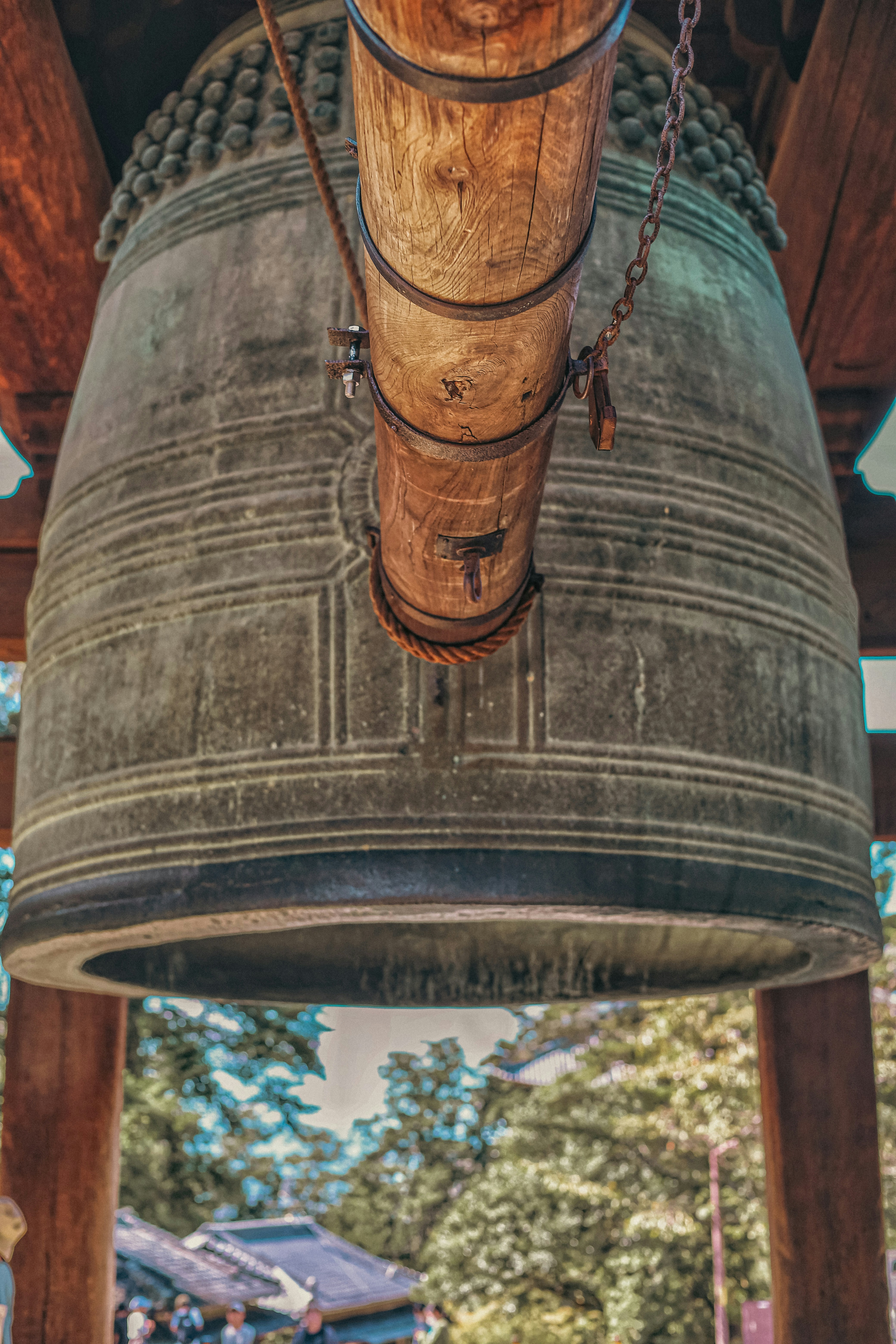 A Quarter-Tone Bell: Upward View of a Historic Gong Under Wooden Beam