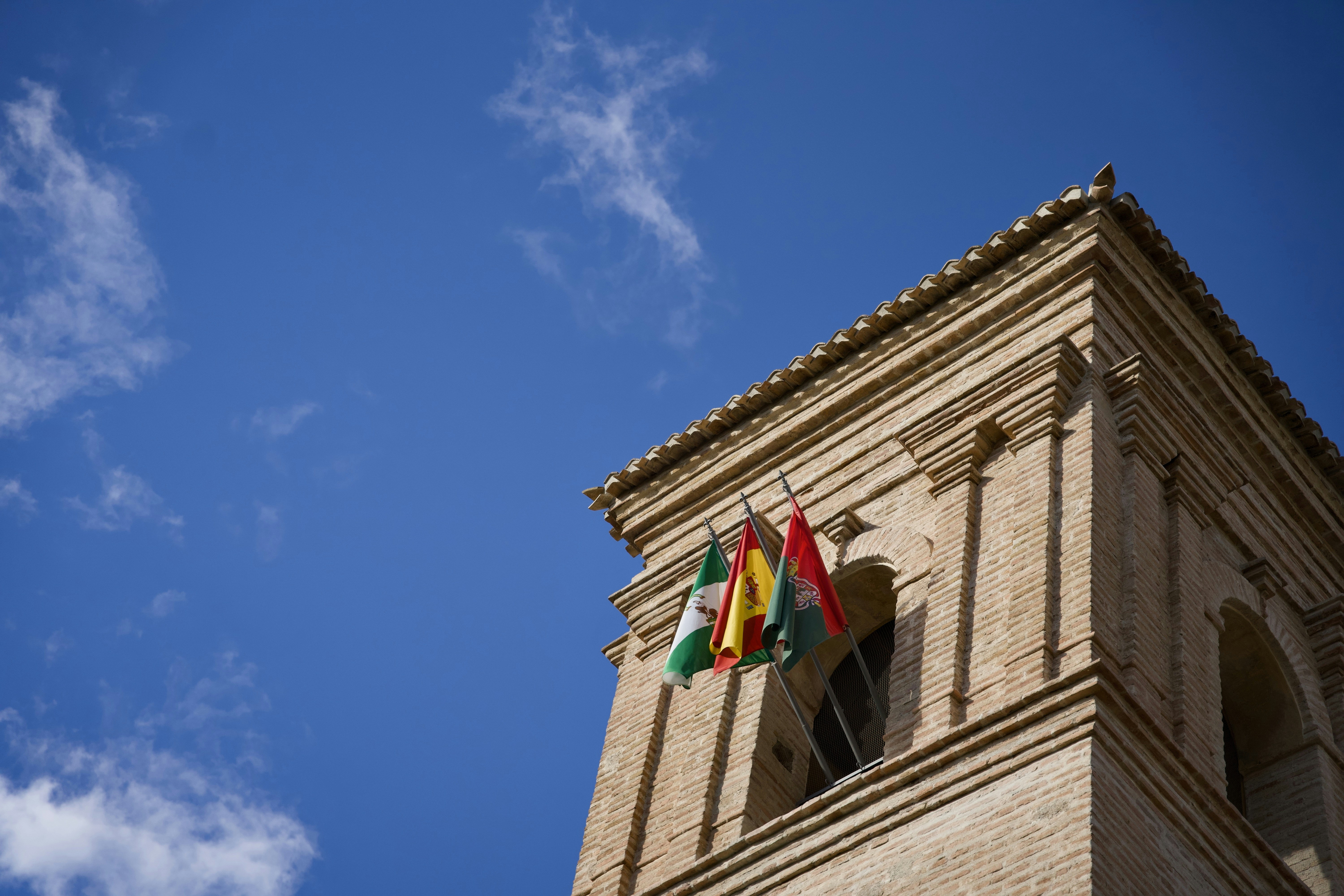 Flagged Stone Spire Under a Blue Sky