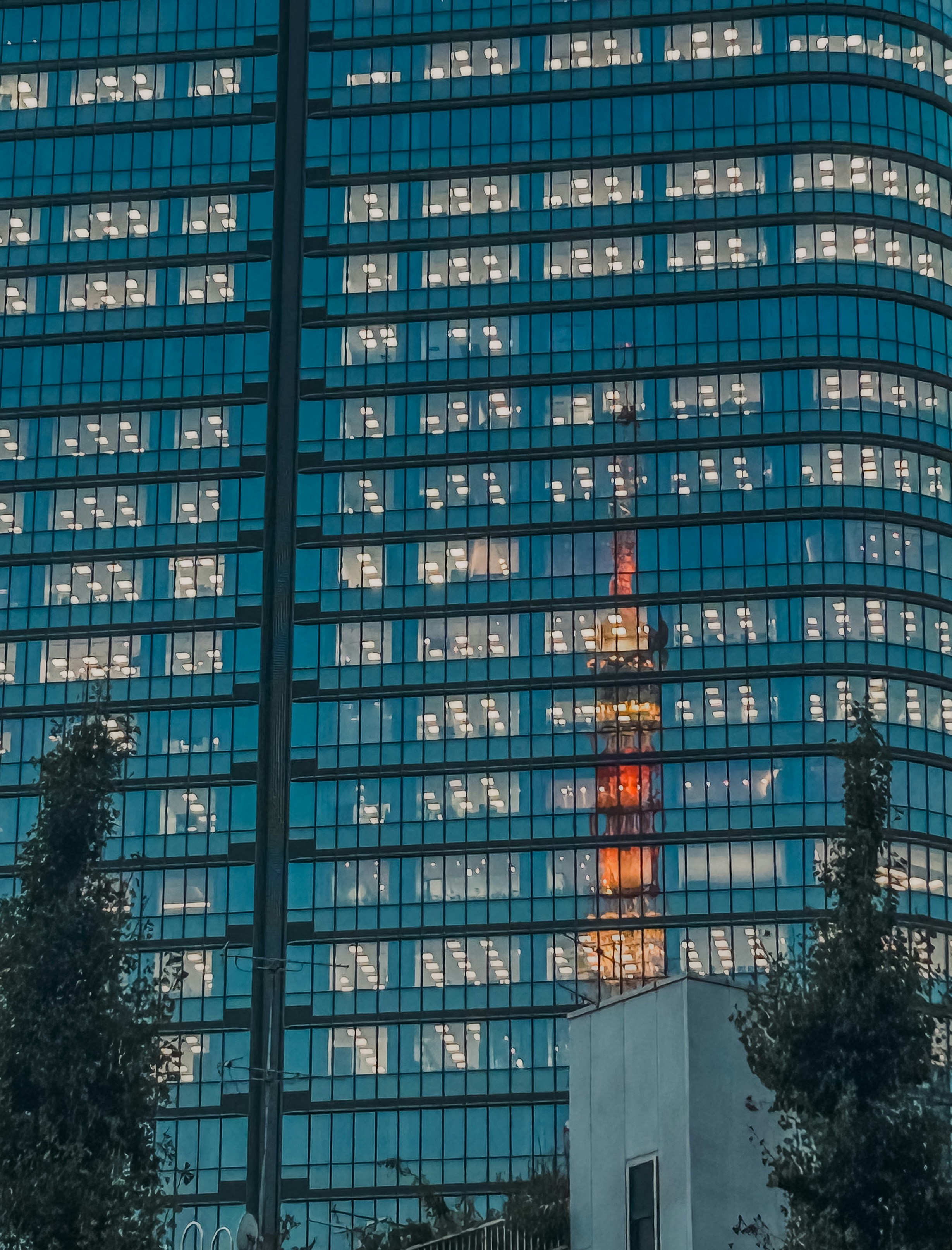 Glass Facade Mirage: Reflections and Neon Accent in a Skyscraper Grid