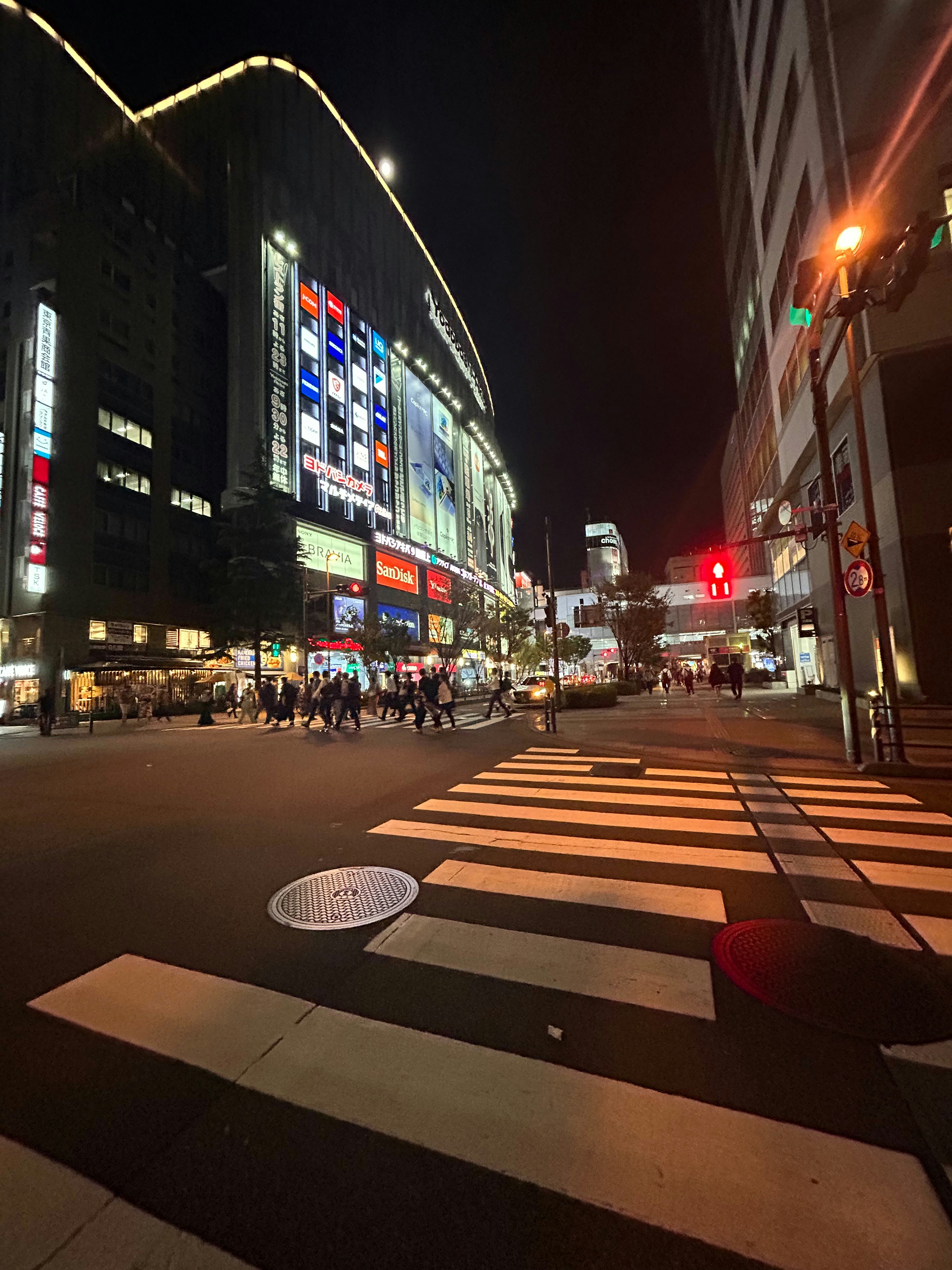 Nightpedestrian Pulse: A Neon Stadium in a City Crossing