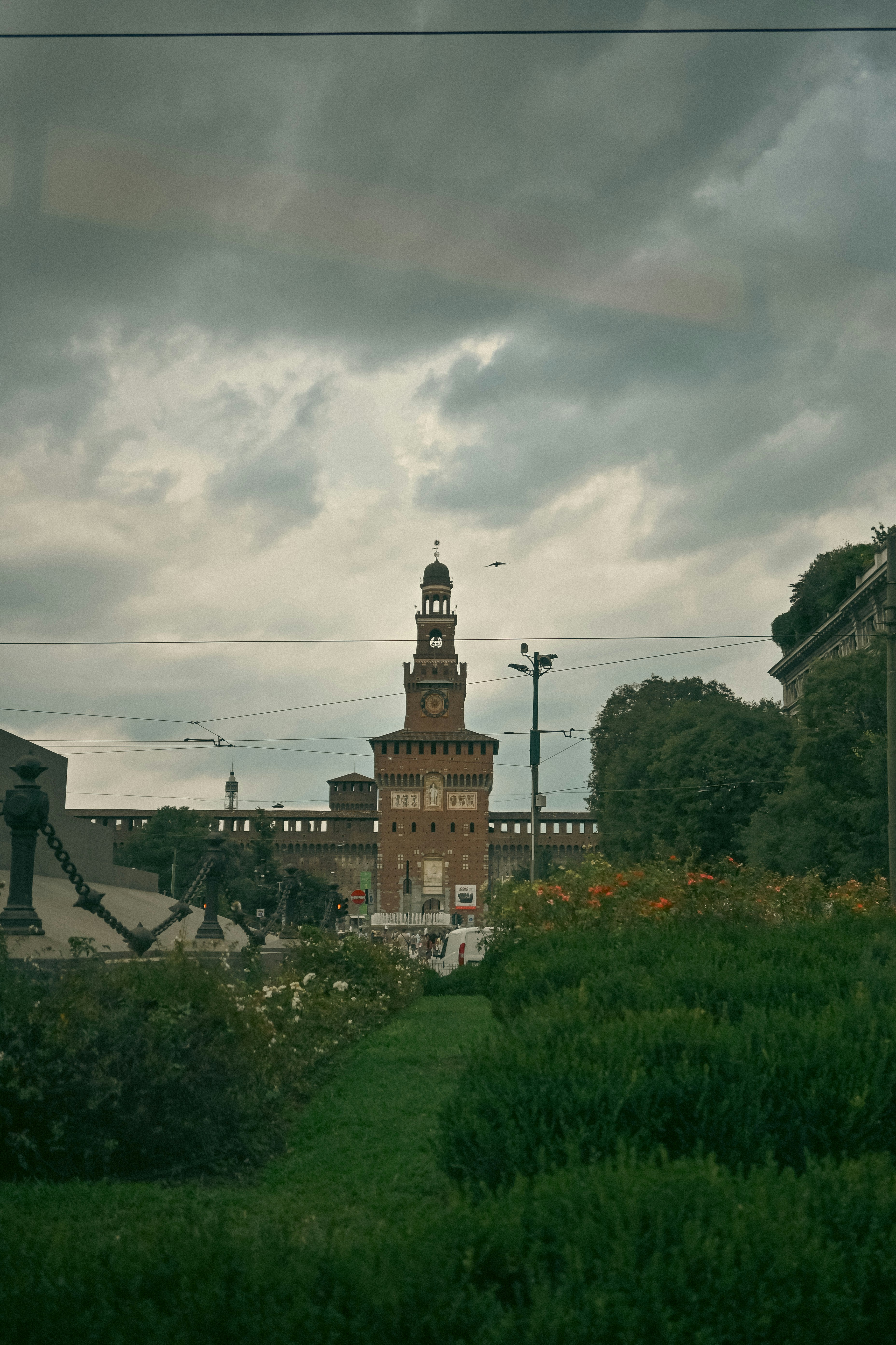 Clocktower at Dusk: A City Garden Framed by Stormy Skies