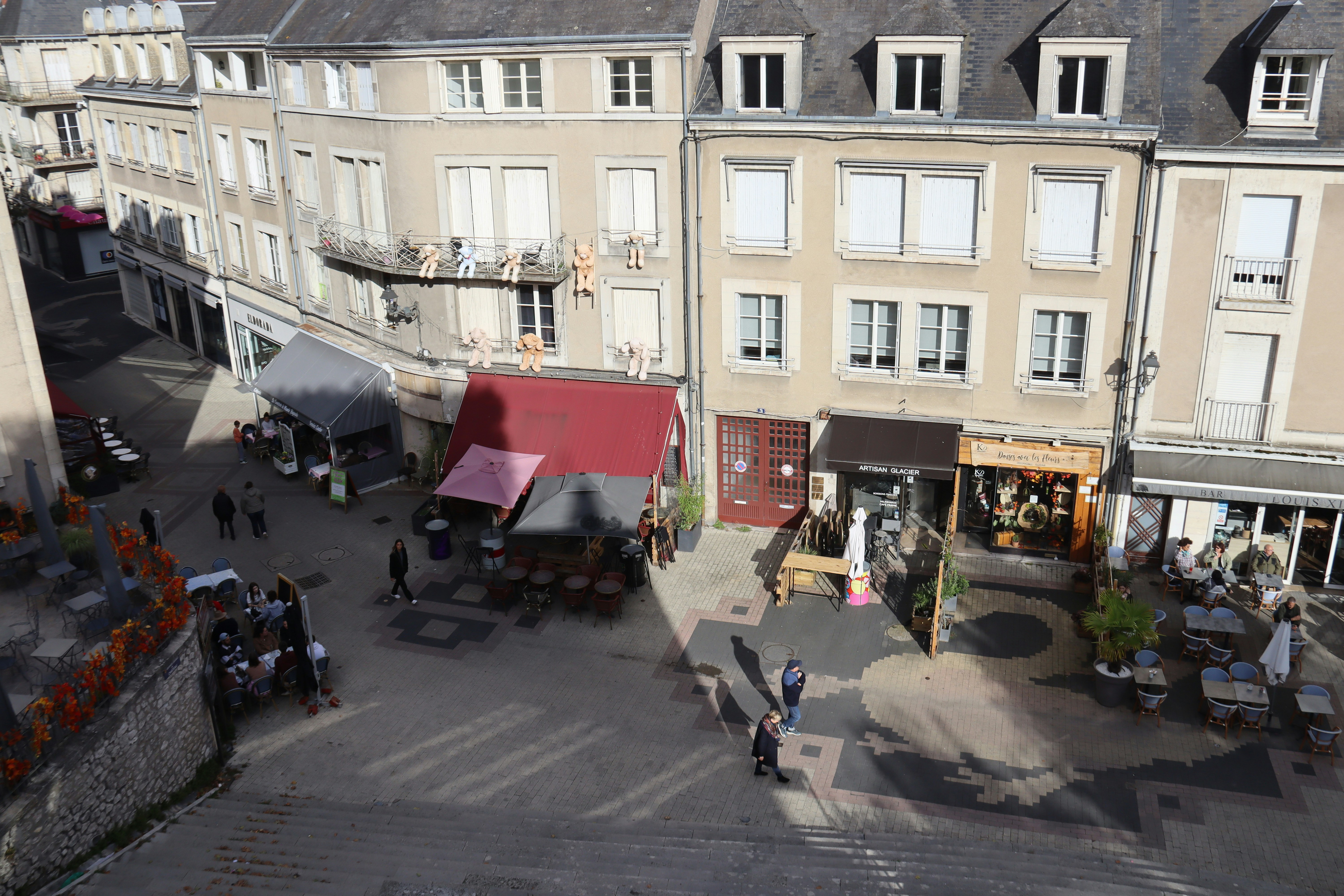 Sunlit Café Row: A Quiet Street Corner in Afternoon Light
