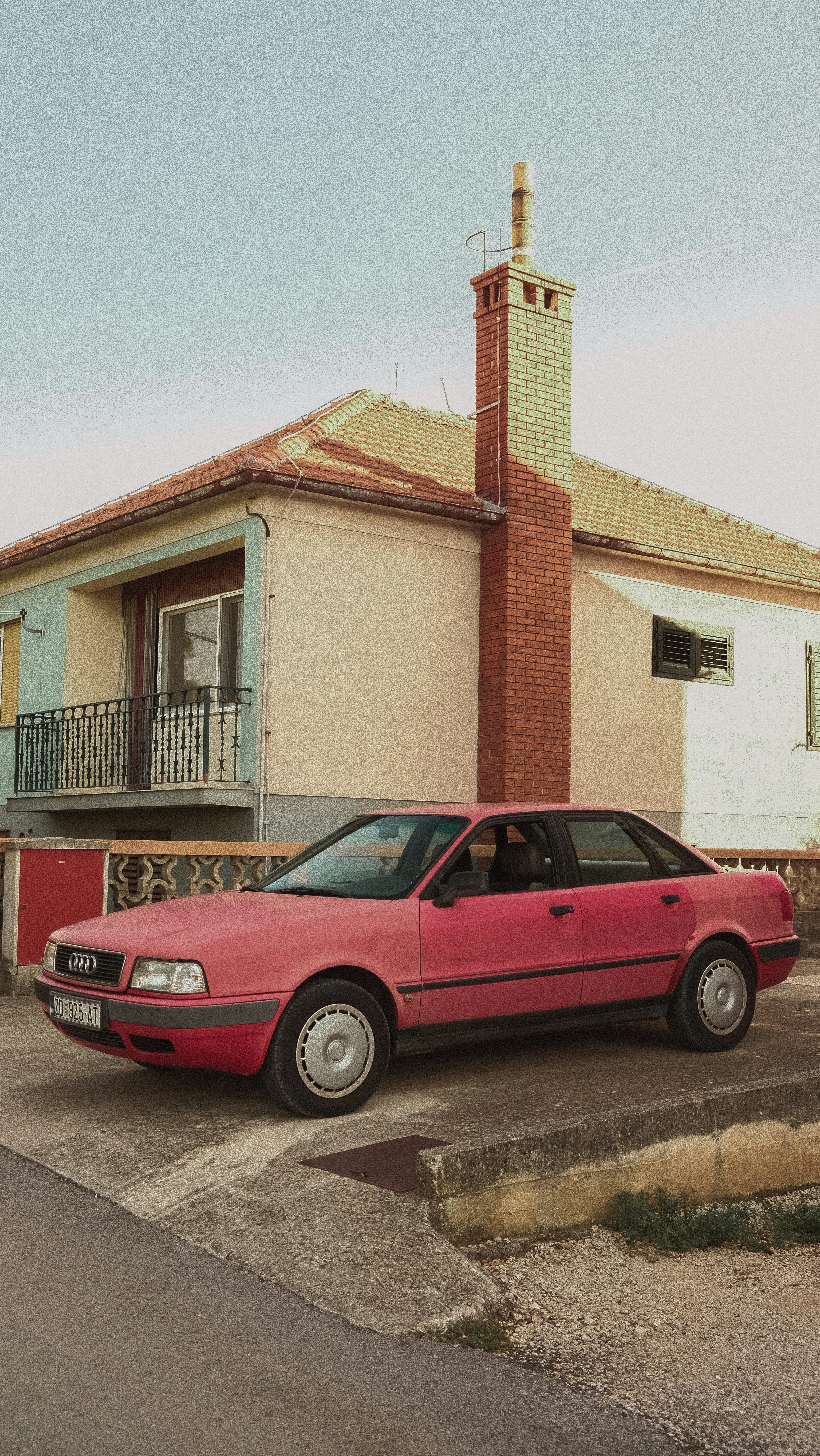 Pink Sedan by a Quiet House