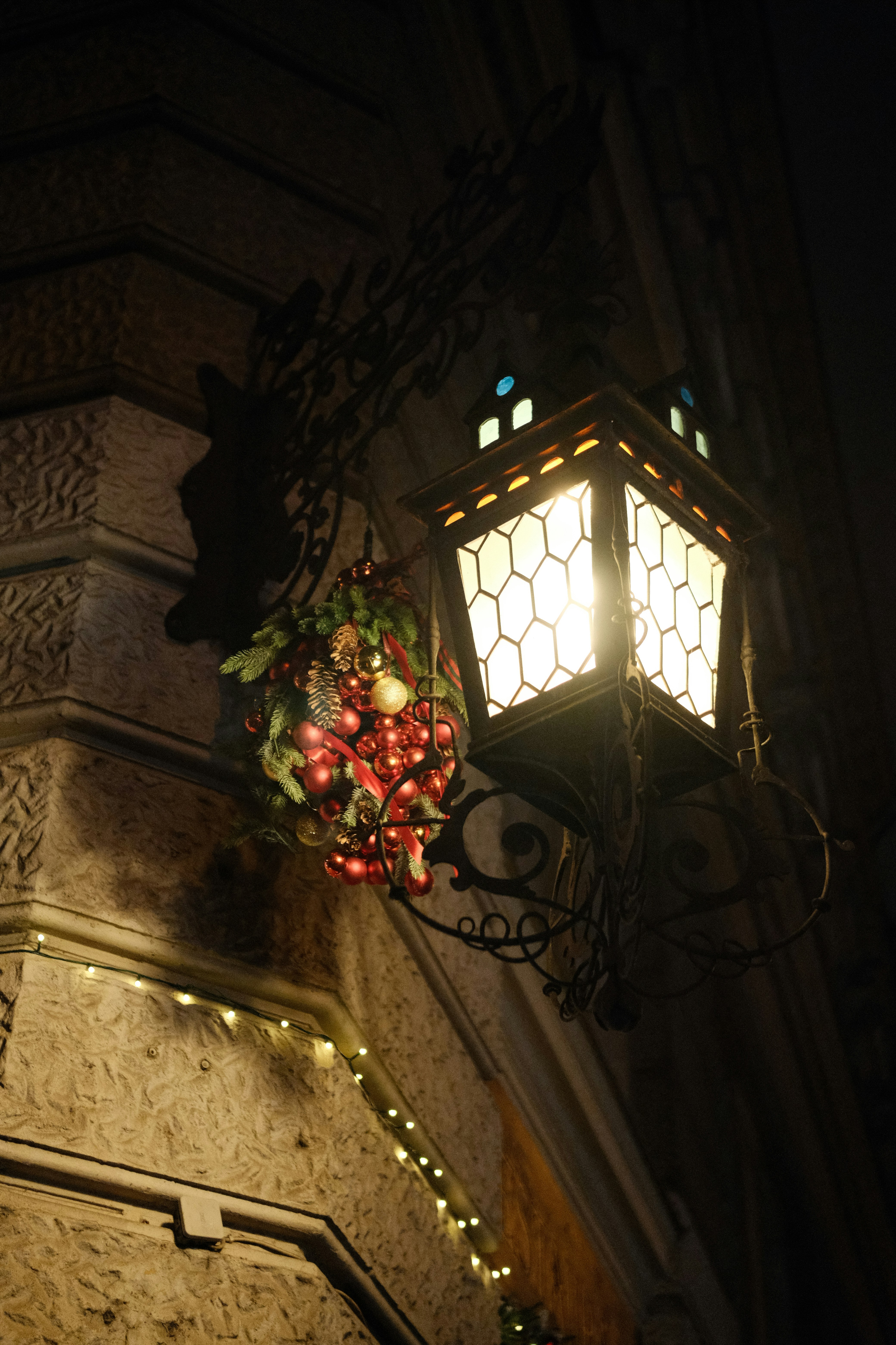 Decorative lantern with holiday wreath at night