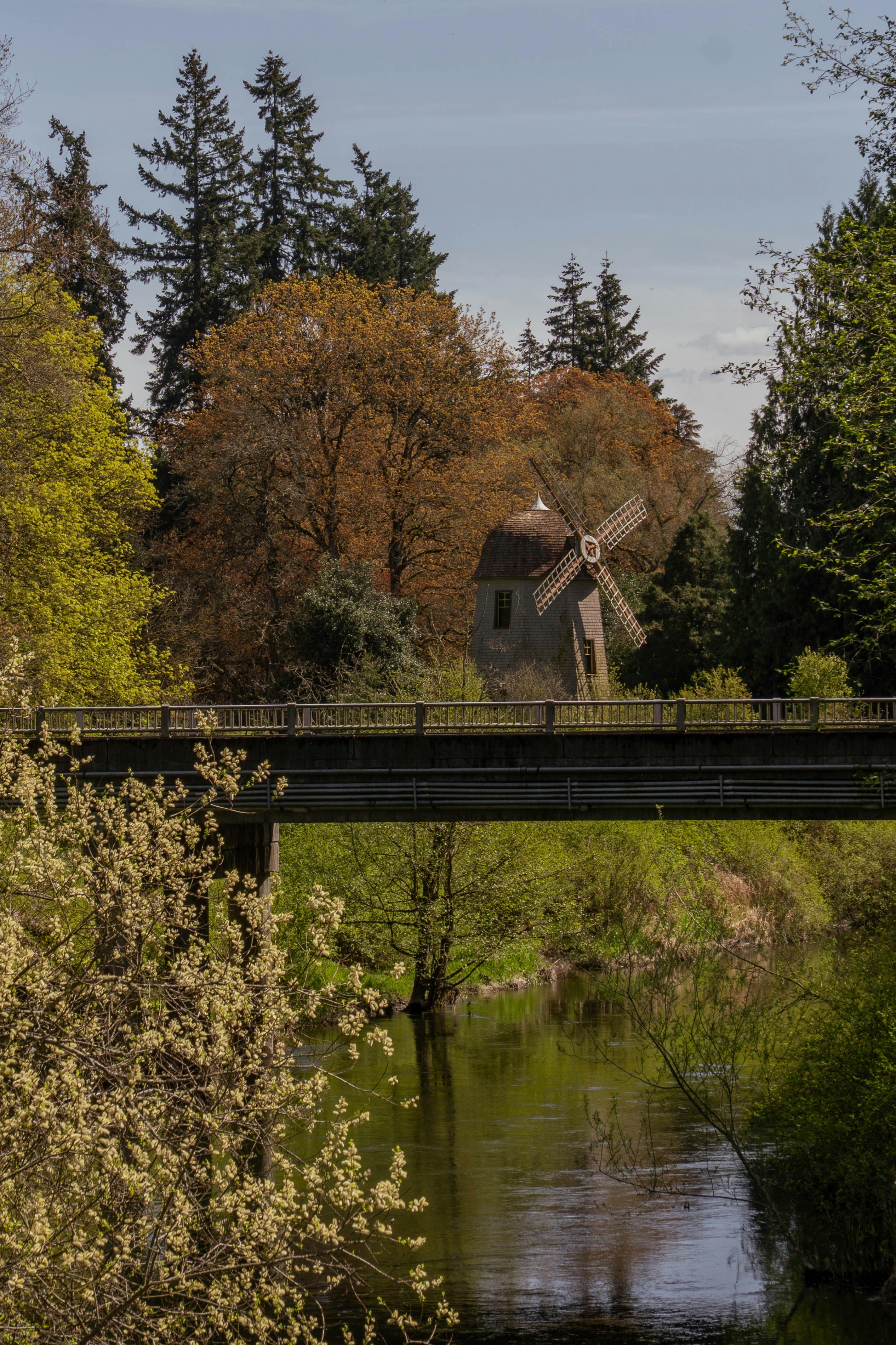 Autumn Windmill over the River: A Quiet Bridge Scene