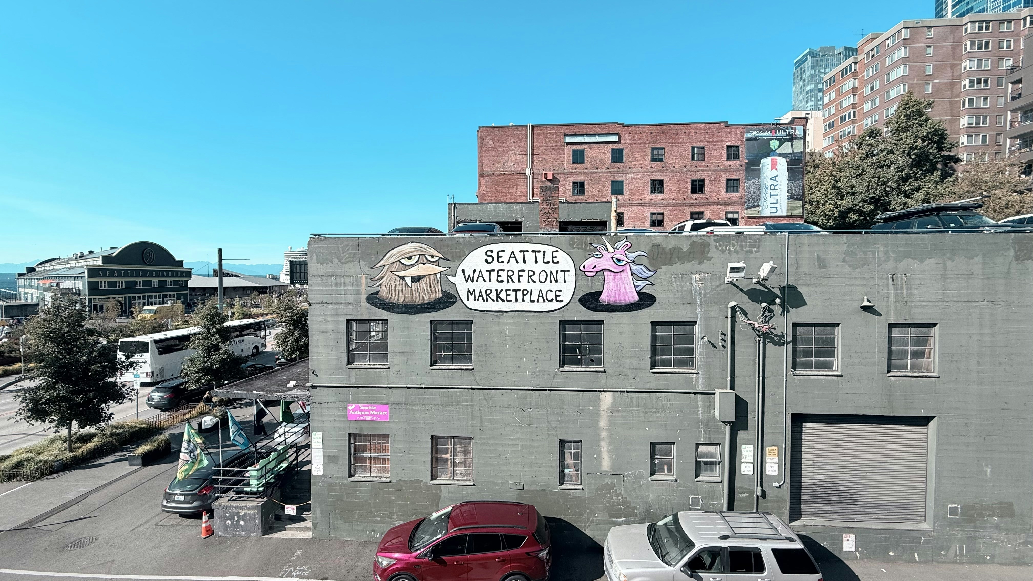 A quirky mural overlooking the Seattle waterfront, with the aquarium in the background and that soft PNW light.