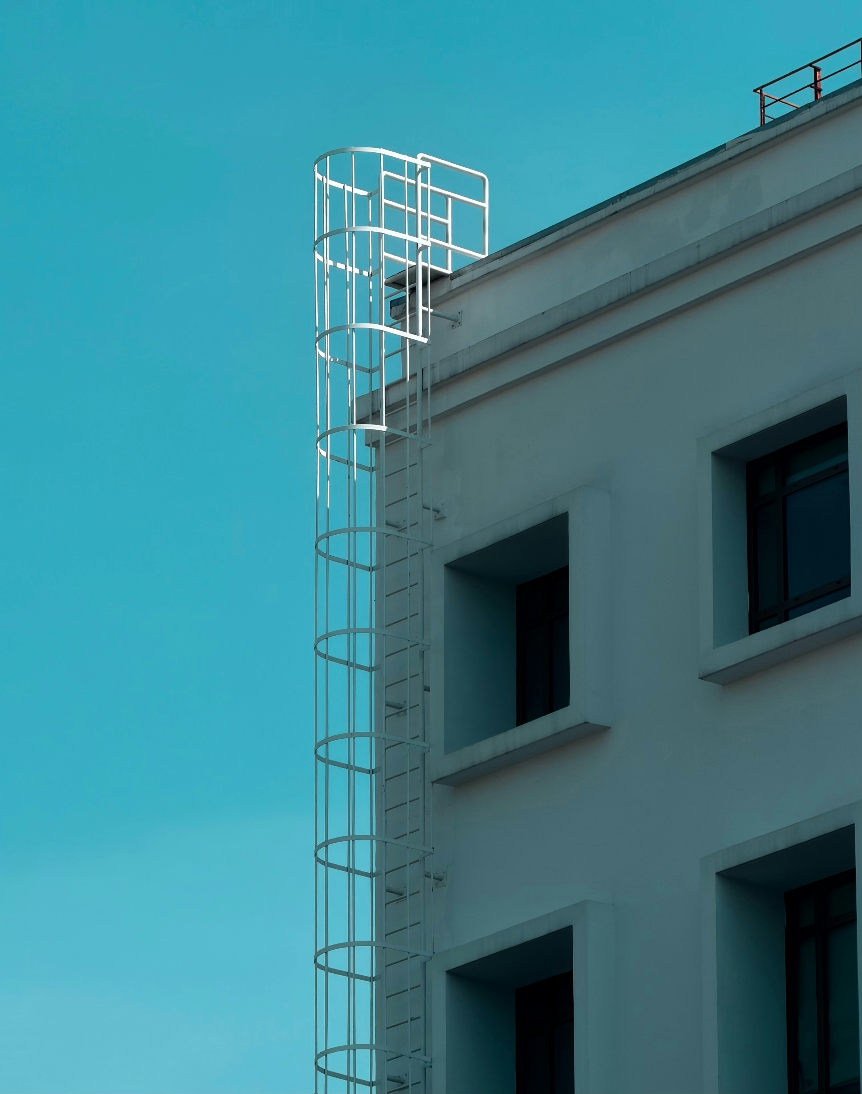 Chrome Ladder Climbing the Sky: A Minimalist Facade