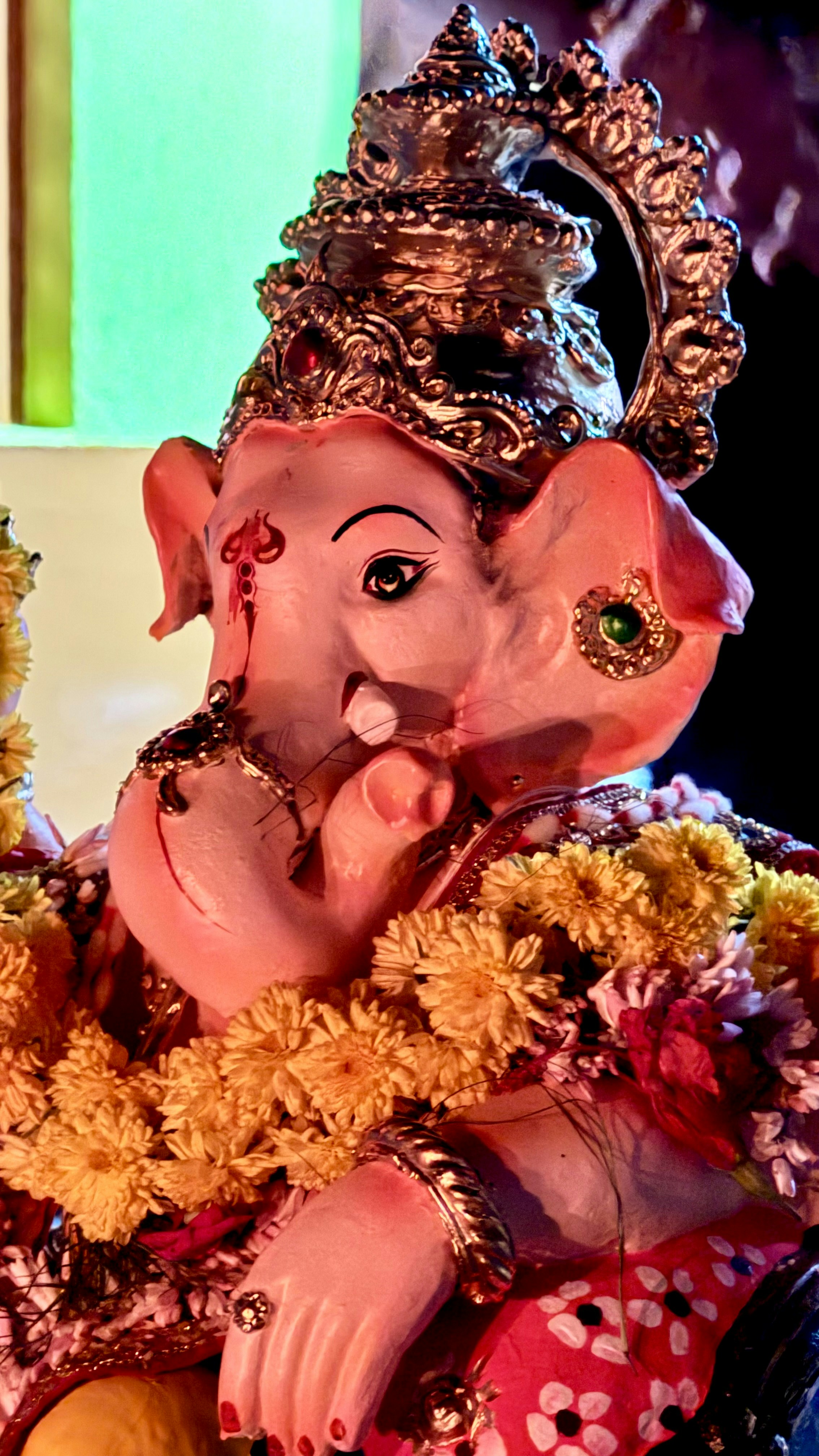 Garlanded Ganesha: devotion in golden light