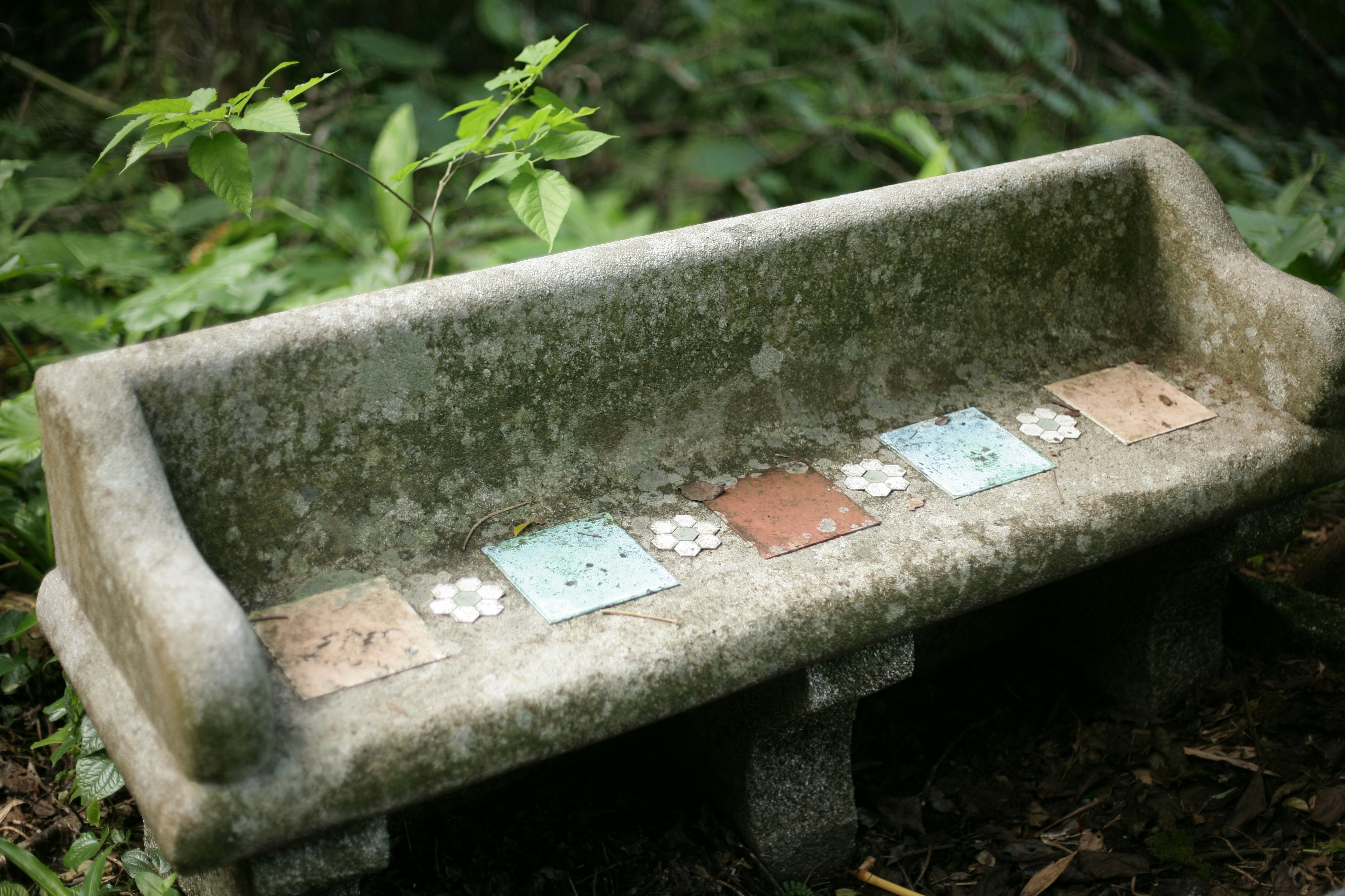 Mossy Bench of Tiles: A Quiet Memorial in the Green