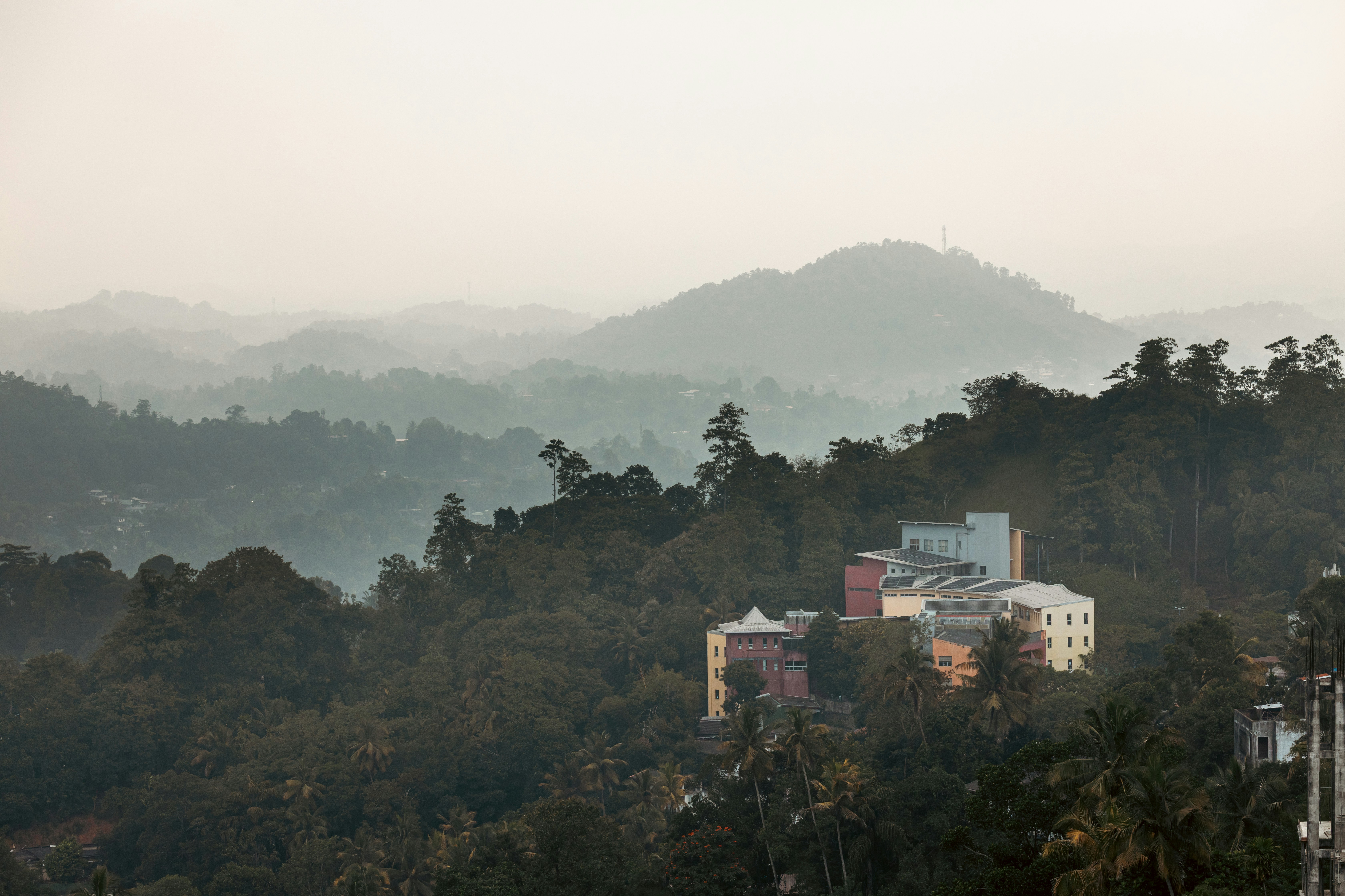 Hilltop Complex Amid Misty Terrains