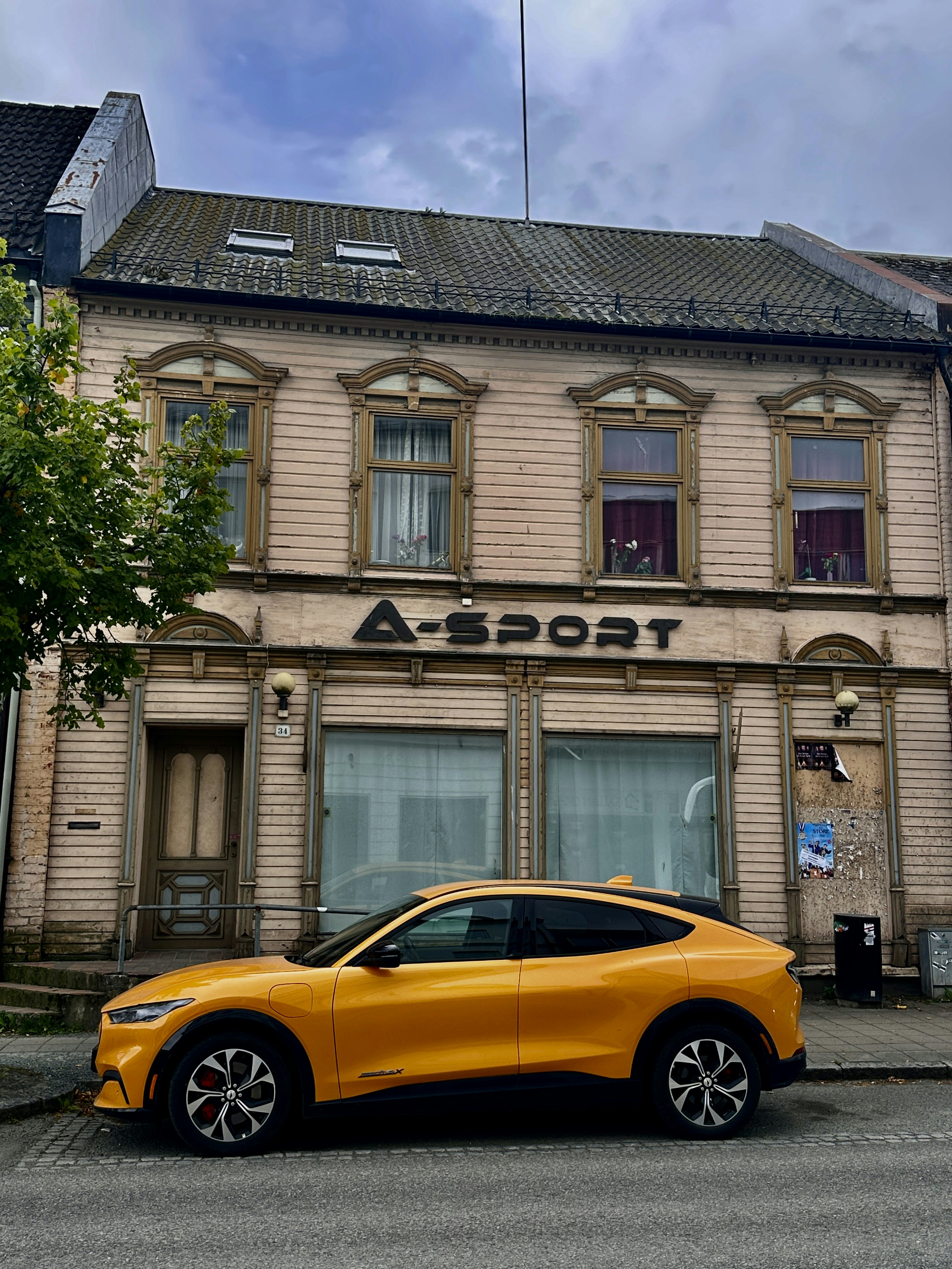 Tesla in front of an old Norwegian building in Levanger/ Norway
