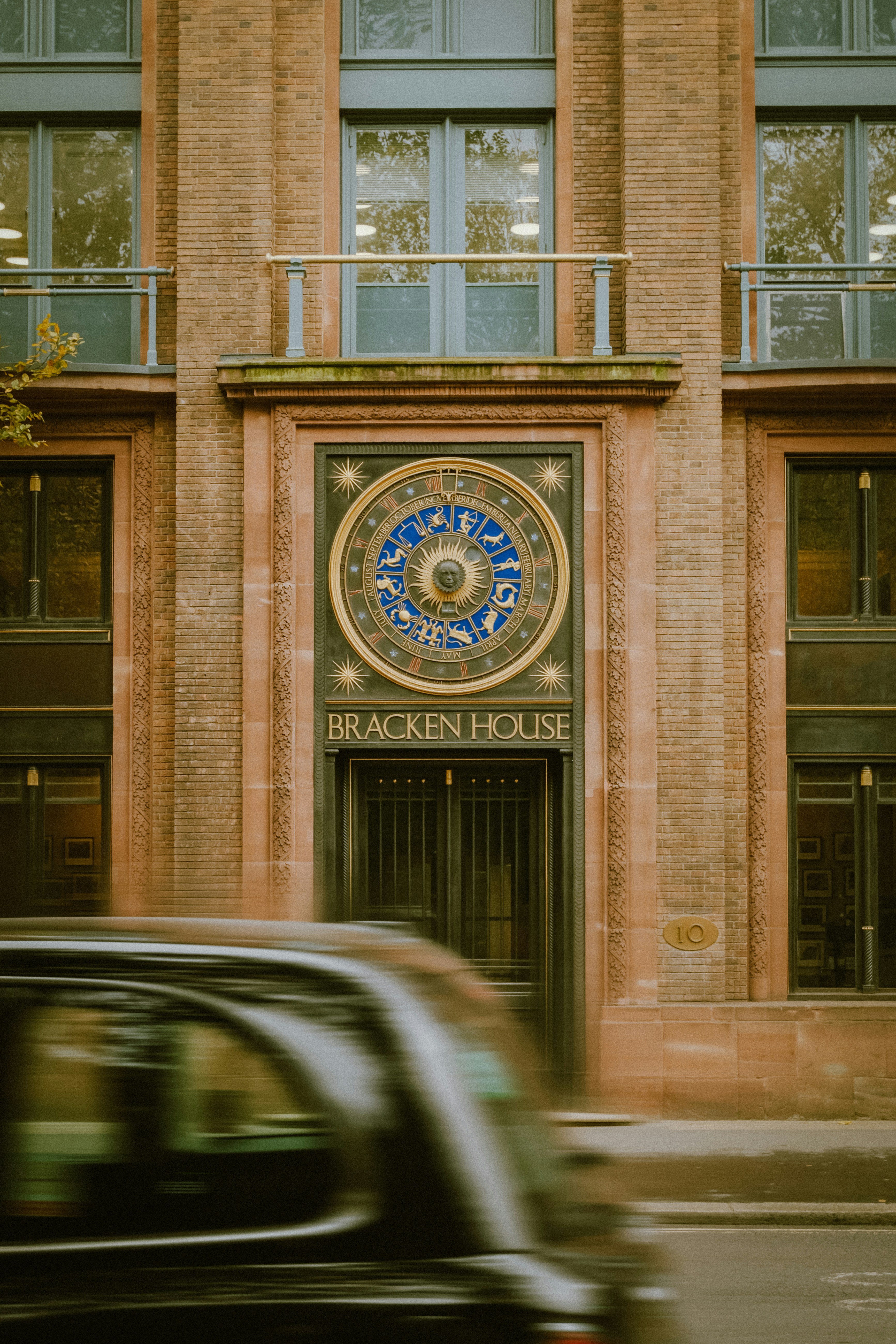 The Clocked Facade: Bracken House Entrance Under a City Spotlight
