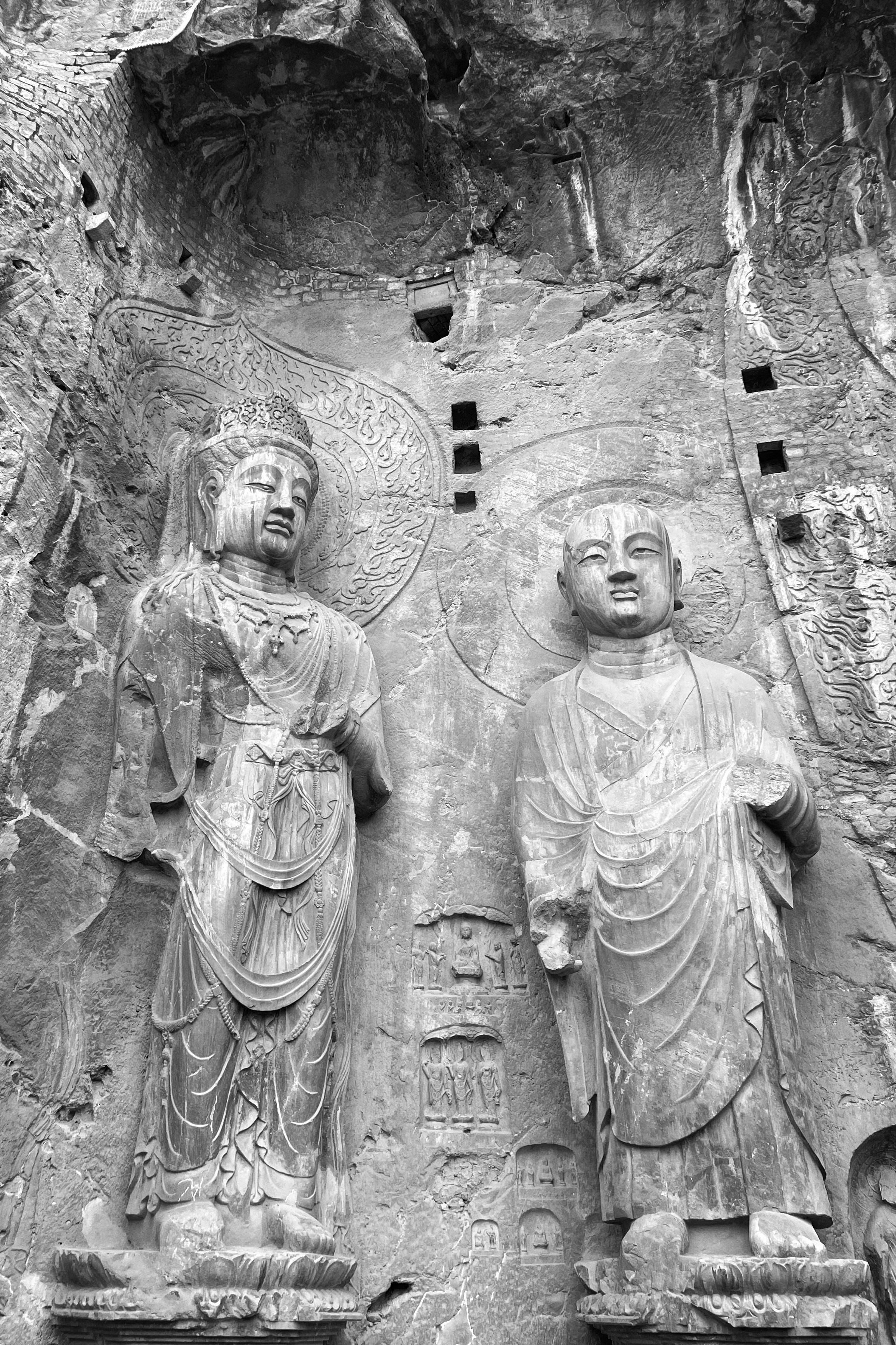 Stone Guardians: Dual Buddhas Carved into a Mountain Niche
