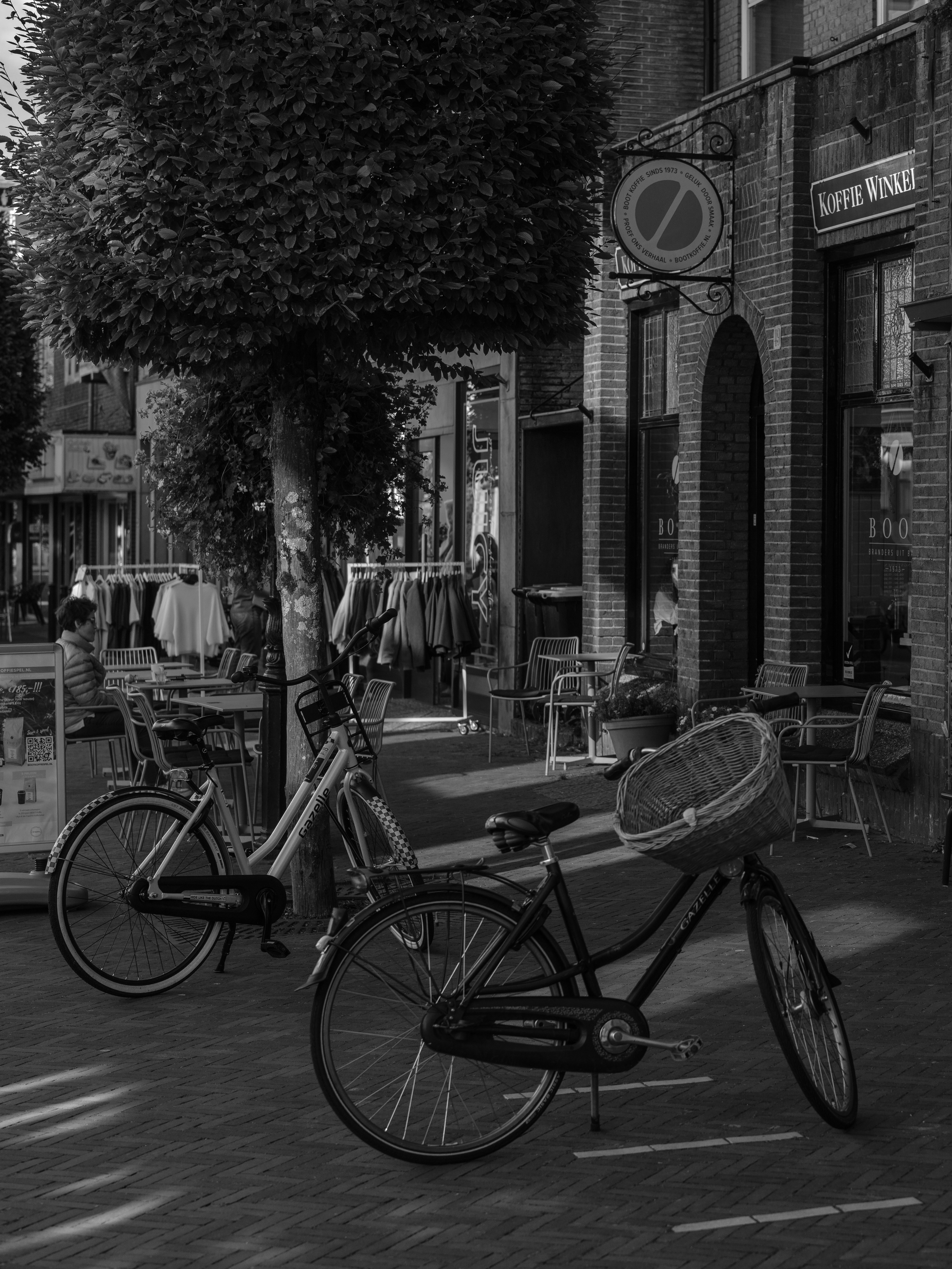 Bicycles on a Narrow City Lane with Outdoor Café Seating