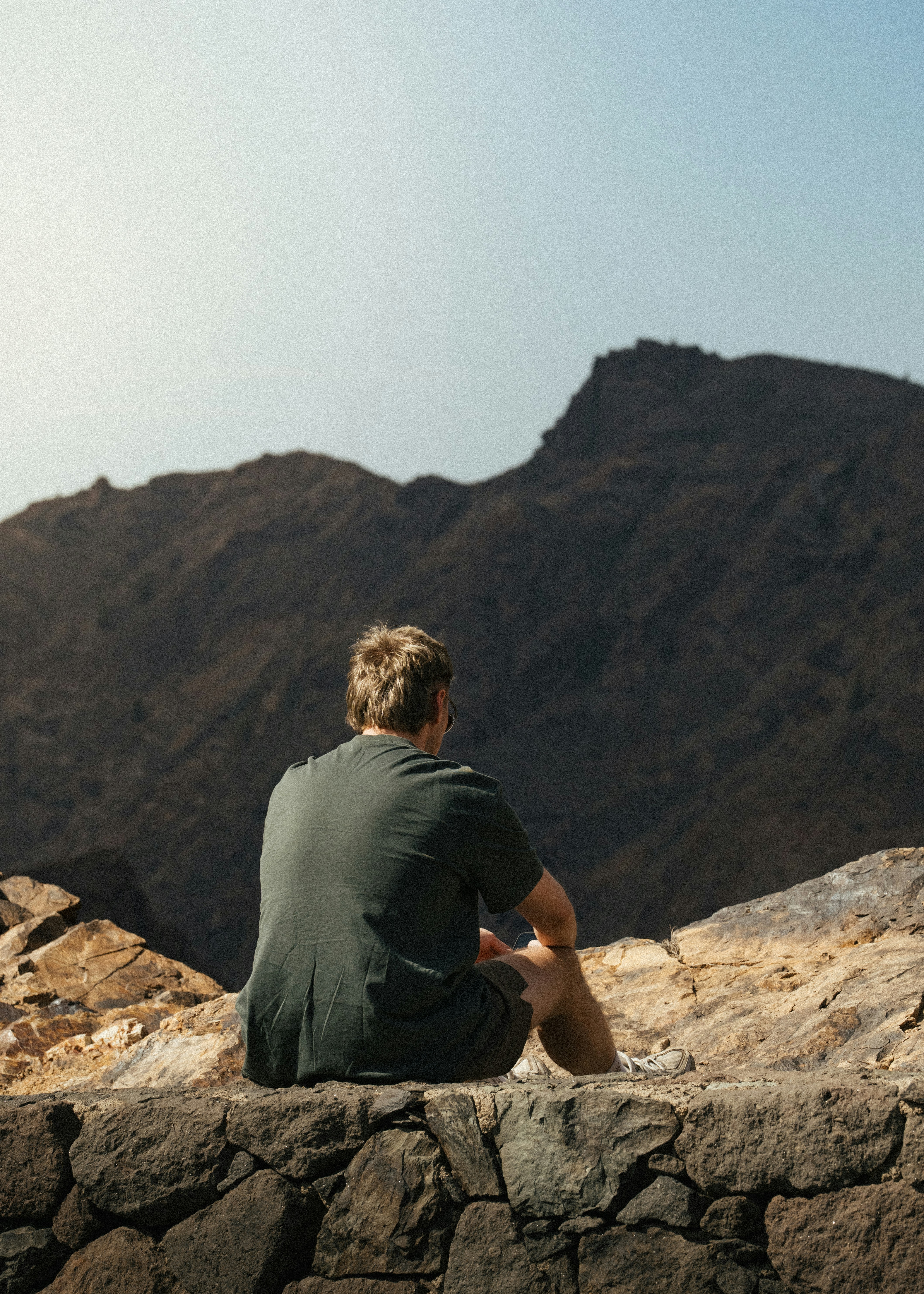 On the Edge of Light: Man at Distant Ridge
