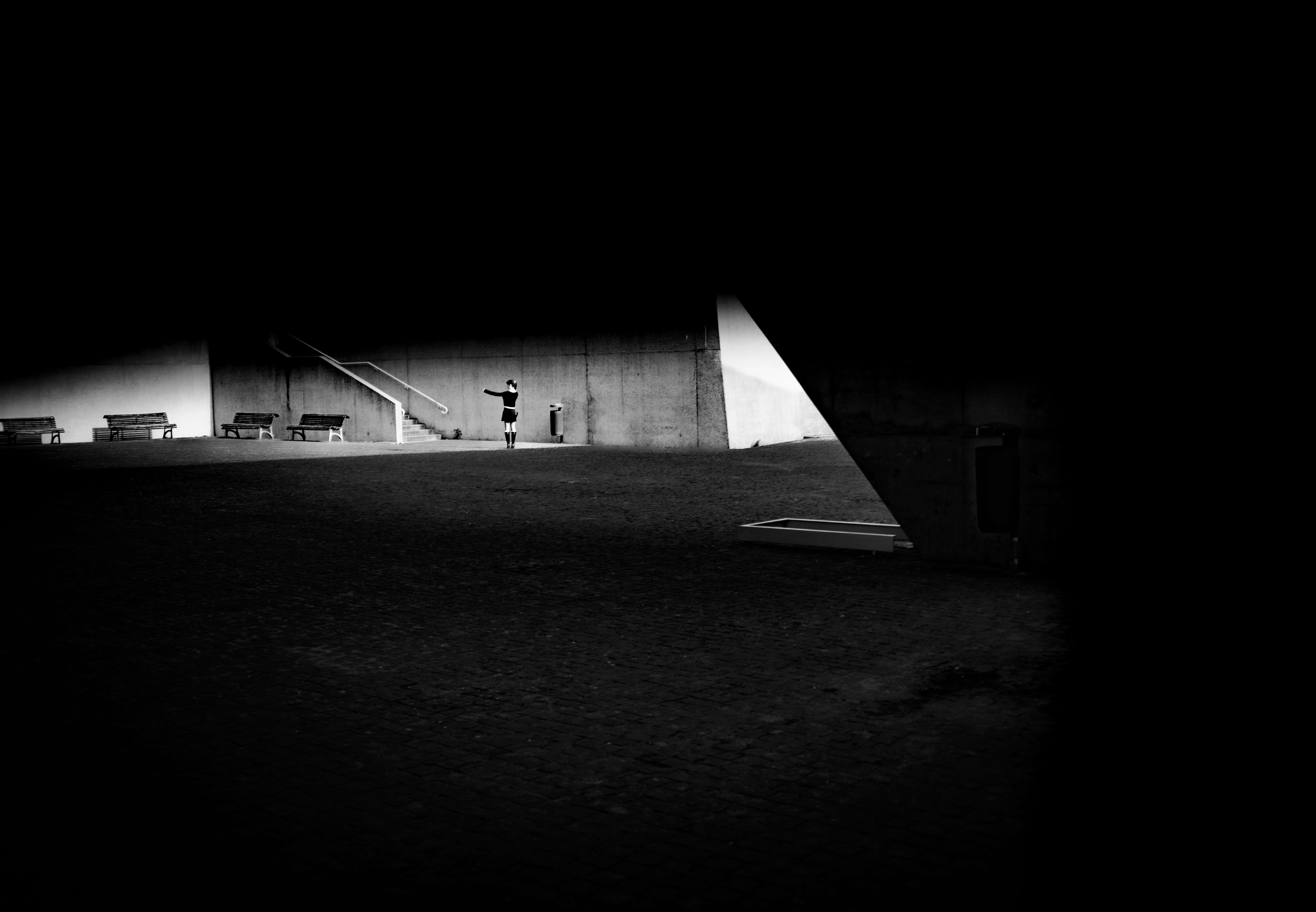 Edge of Light: A Quiet Figure in a Monochrome Courtyard