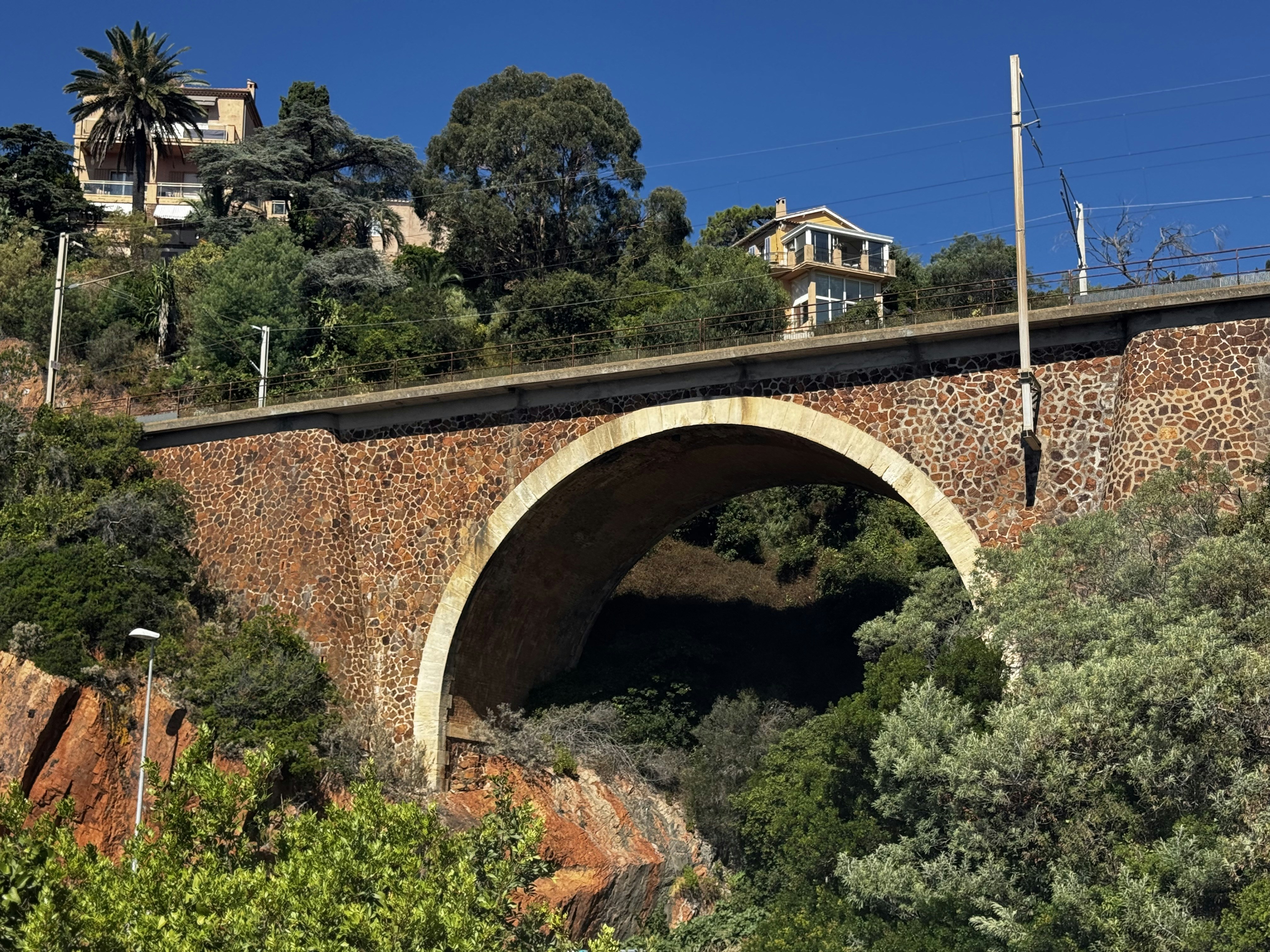 Stone Arch Beneath a Hillside A-Lined Bridge