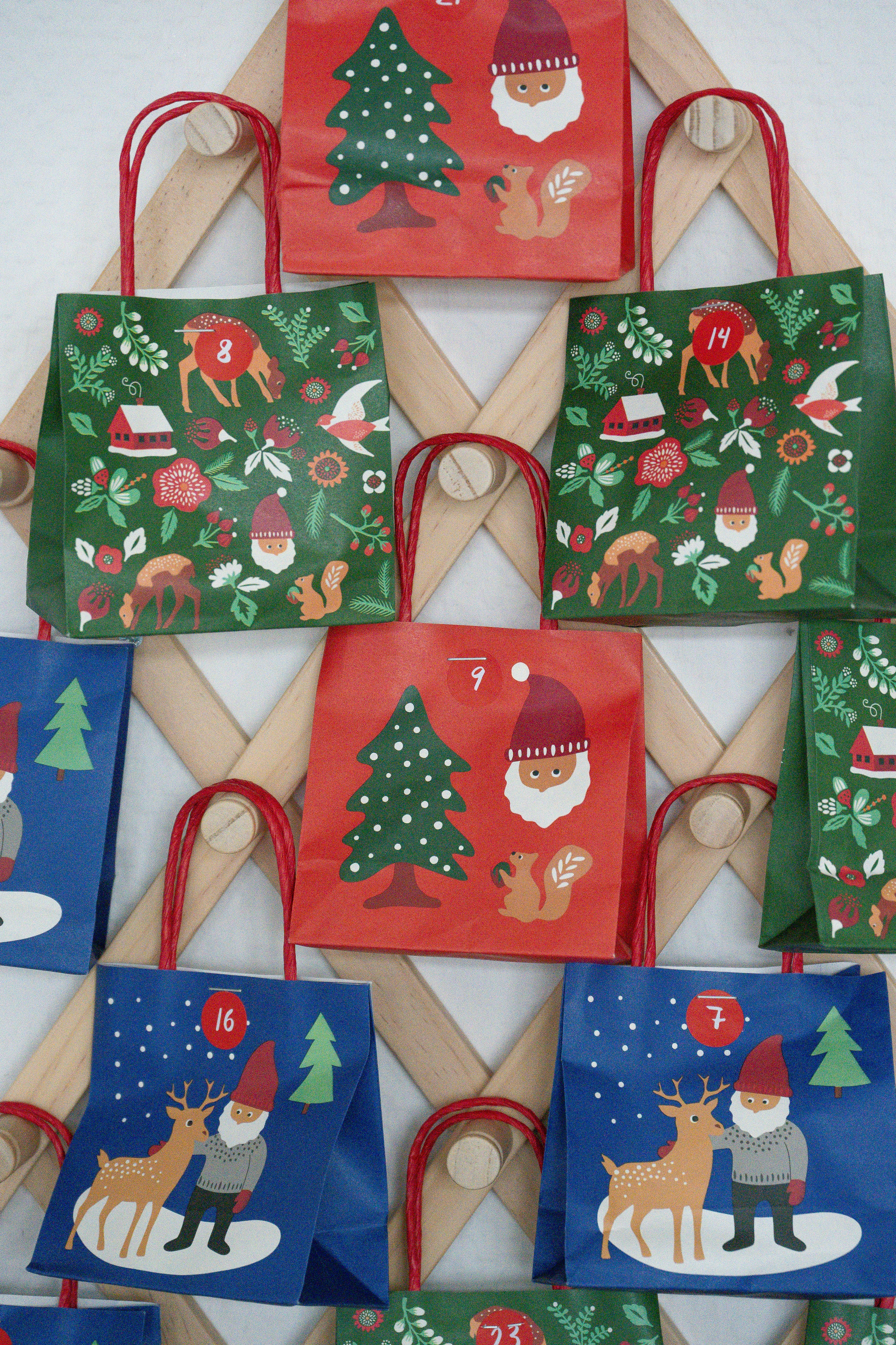 Symmetrical Holiday Parade: Colorful Gift Bags on a Wooden Lattice