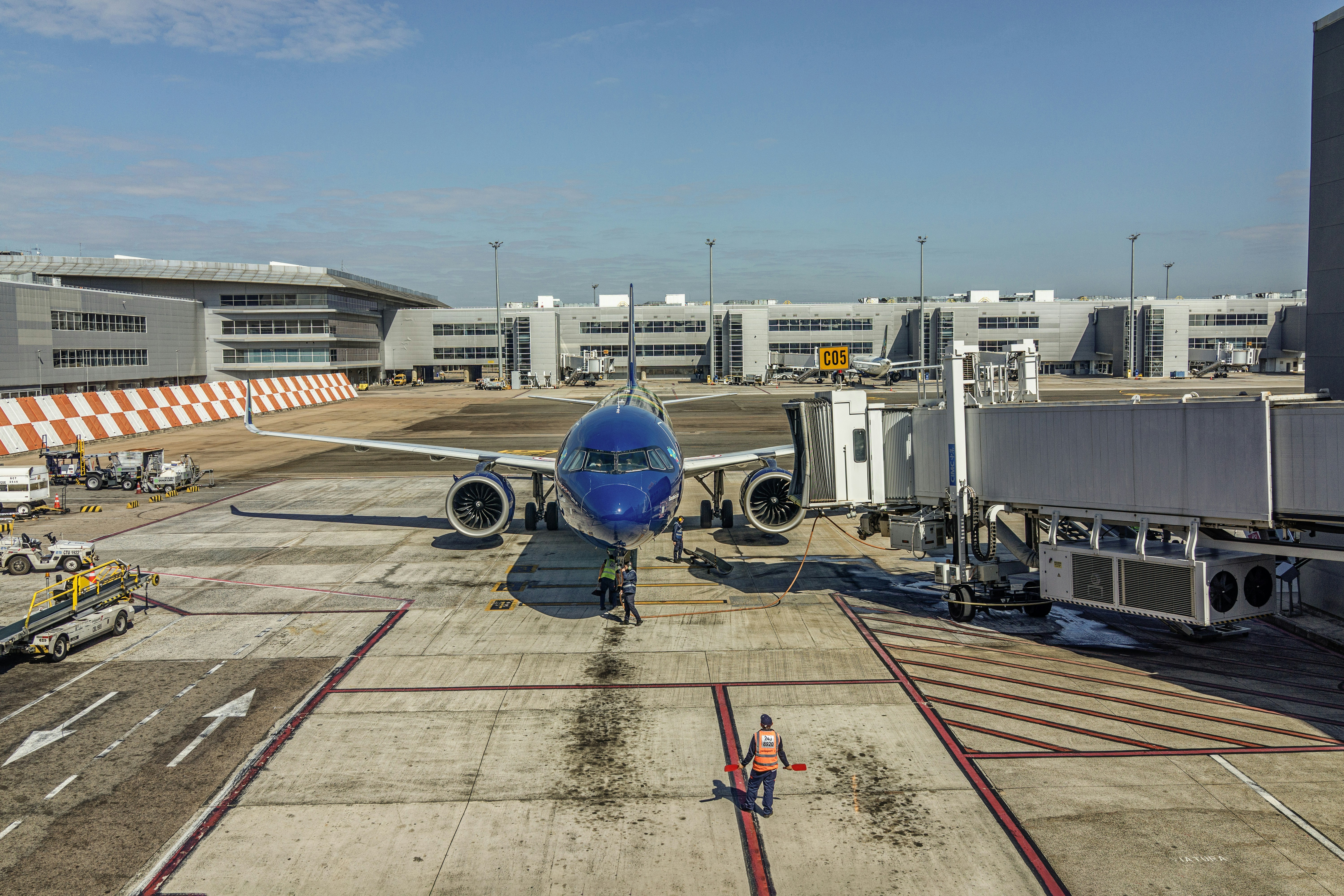Blue Jet at Gate: Ground Crew in Focus