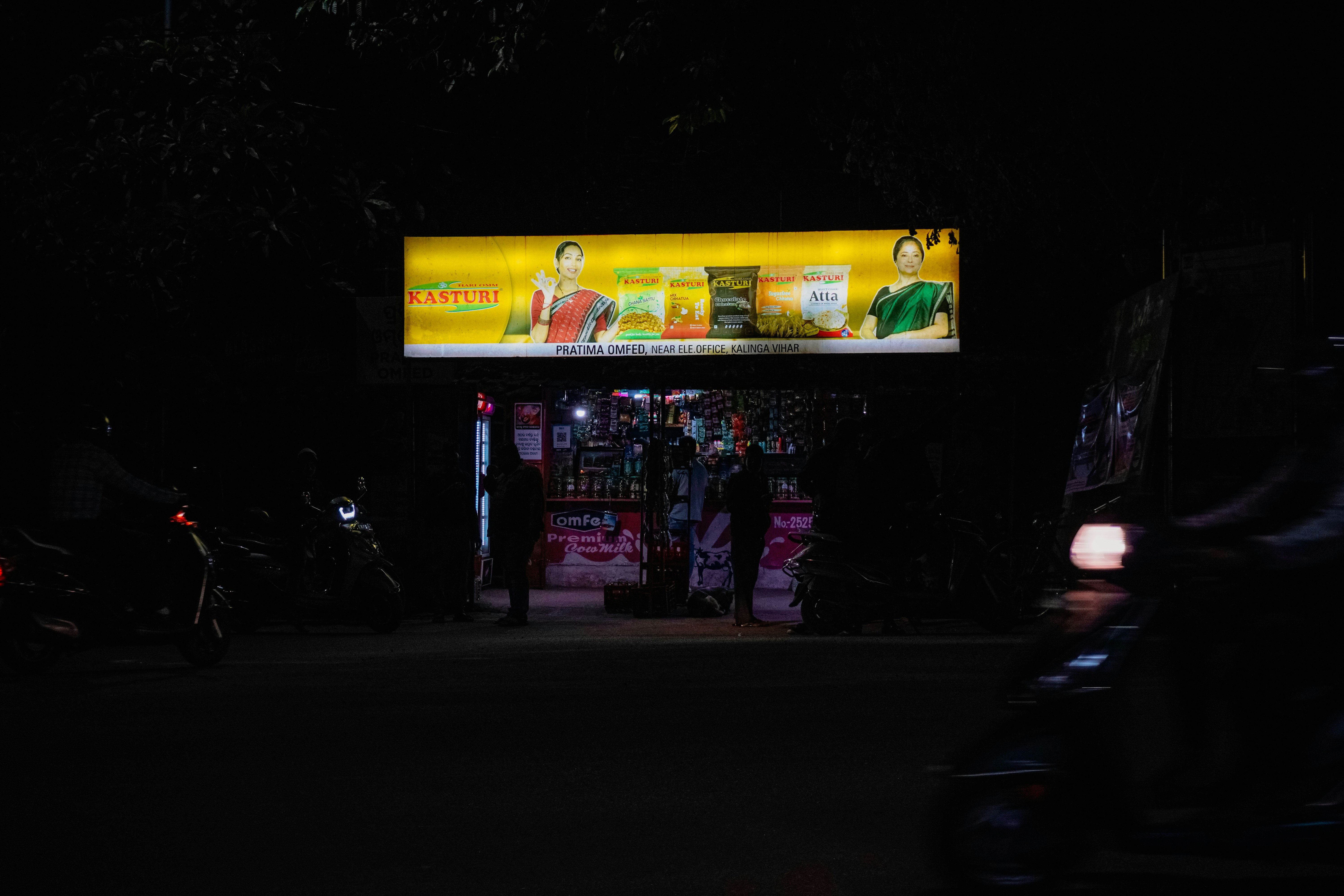 Neon Pharmacy Signage Illuminates a Quiet Street at Night