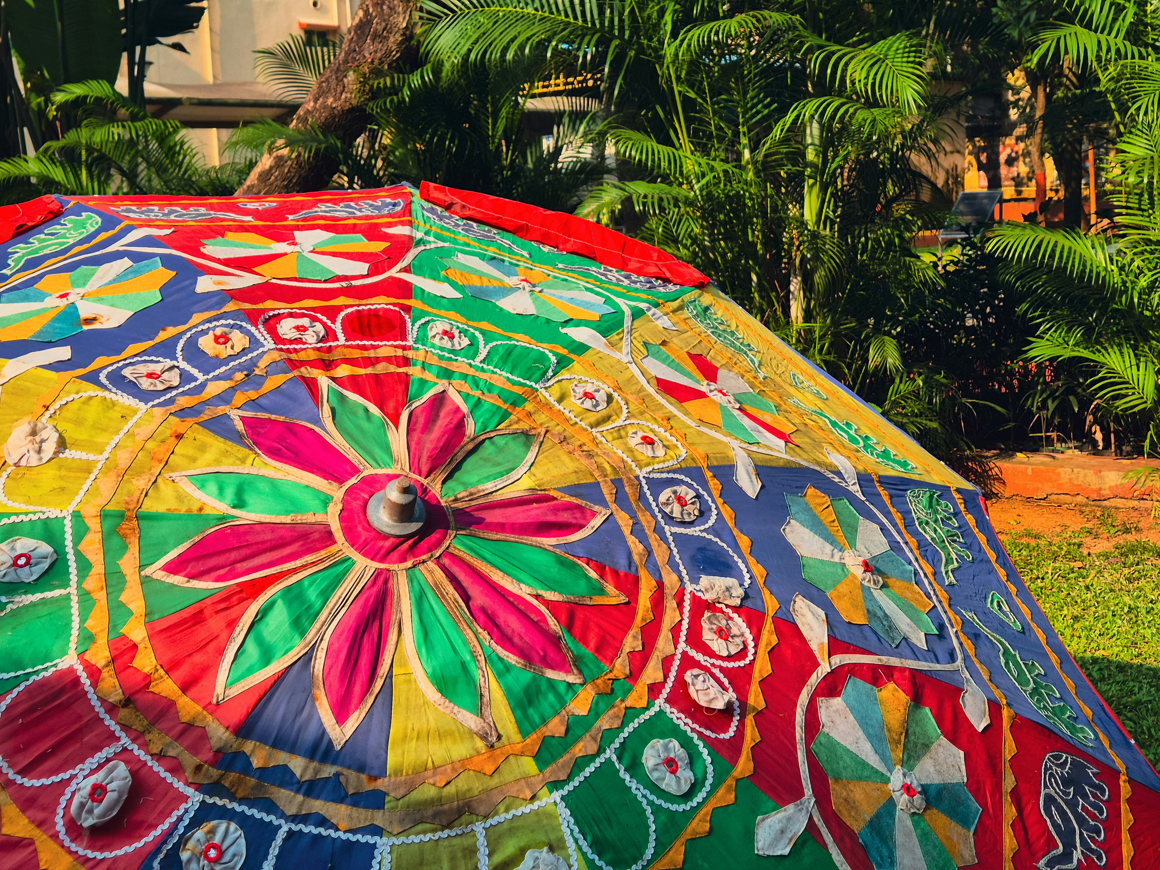 Vibrant Mandala Umbrella Spokes Across a Lush Garden