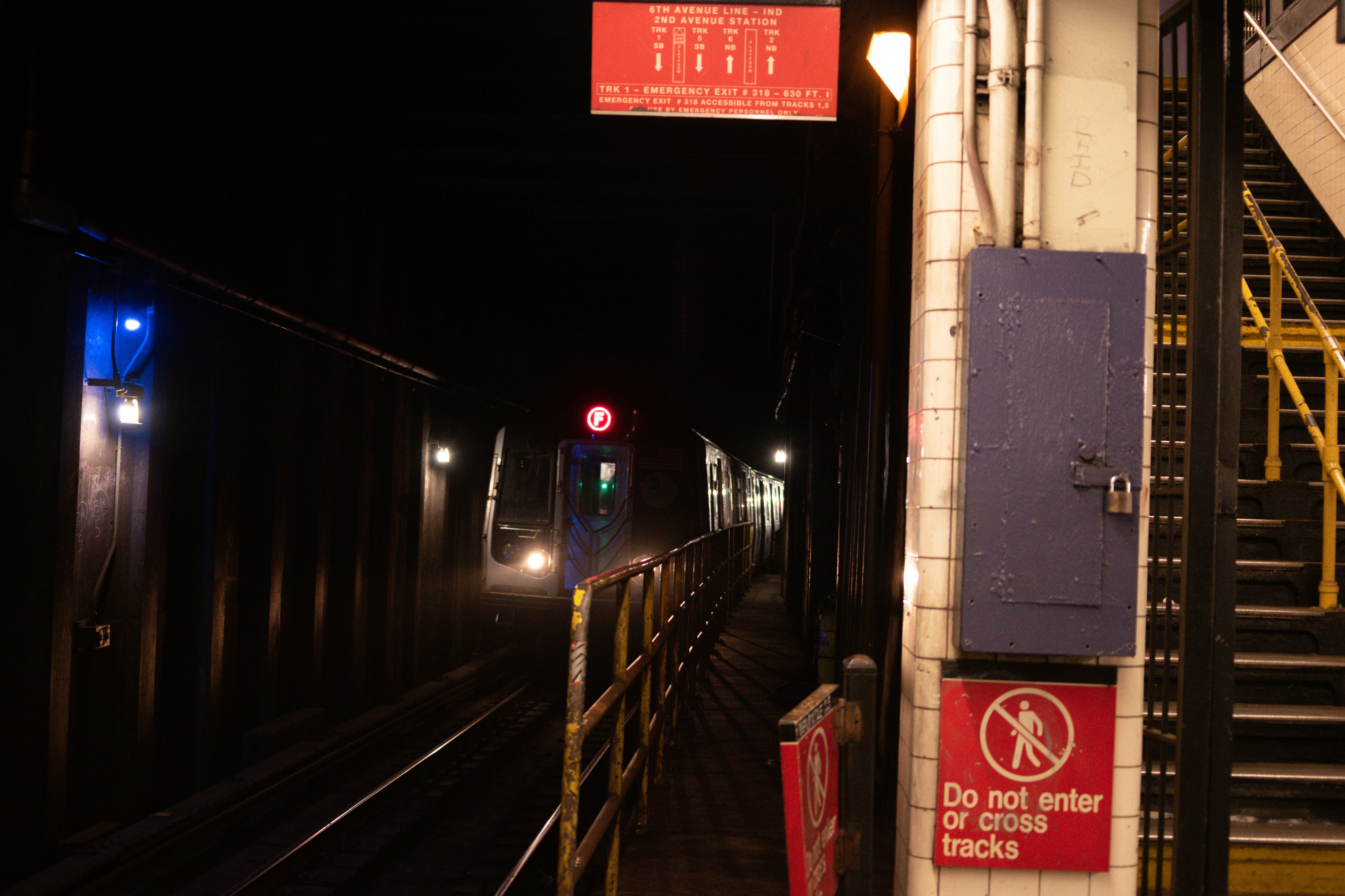 Midnight Platform Echo: Neon Signage and a Dimly Lit Track