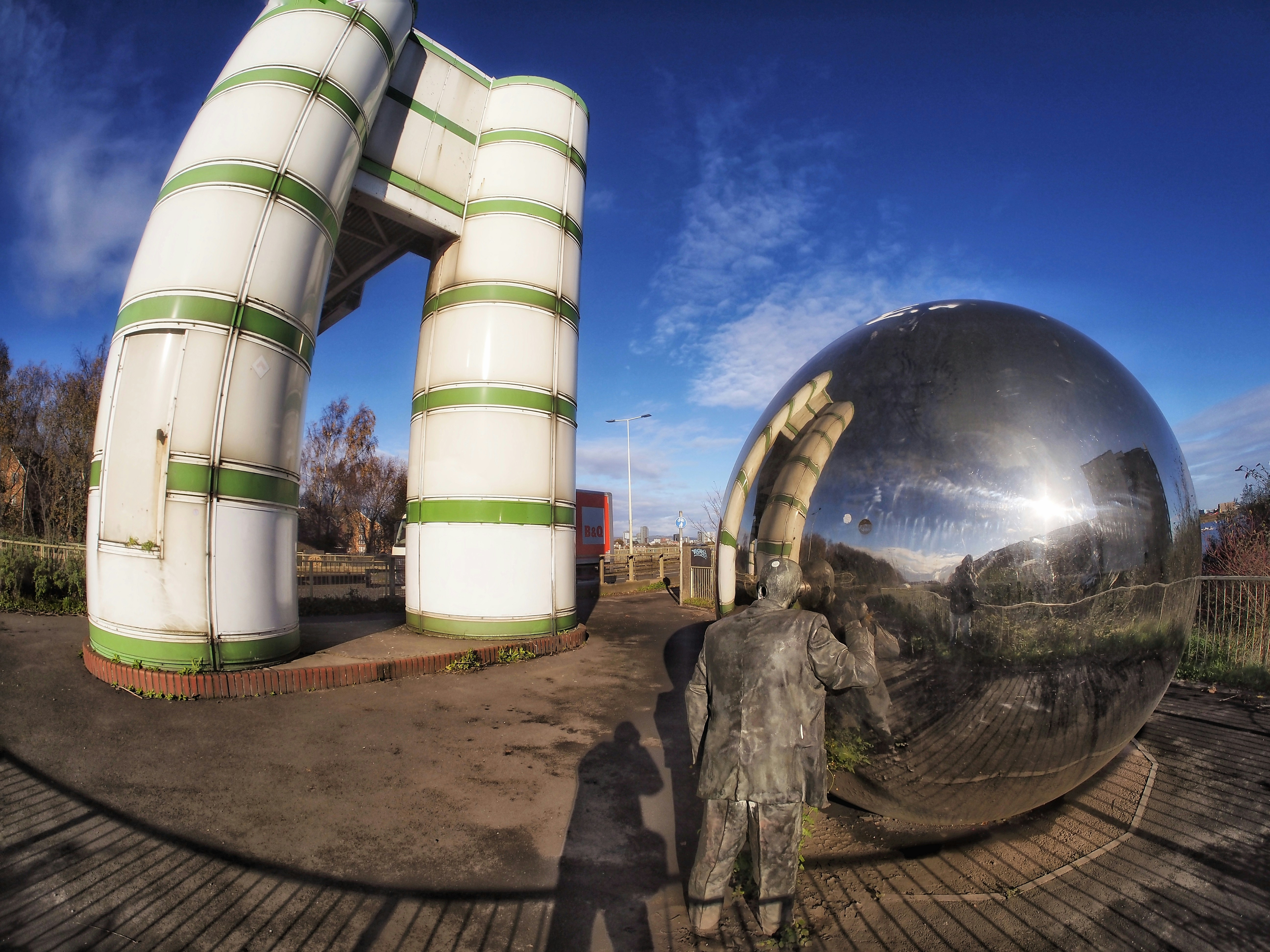 Reflective Sphere and Industrial Arch: A Distorted Day at the Park