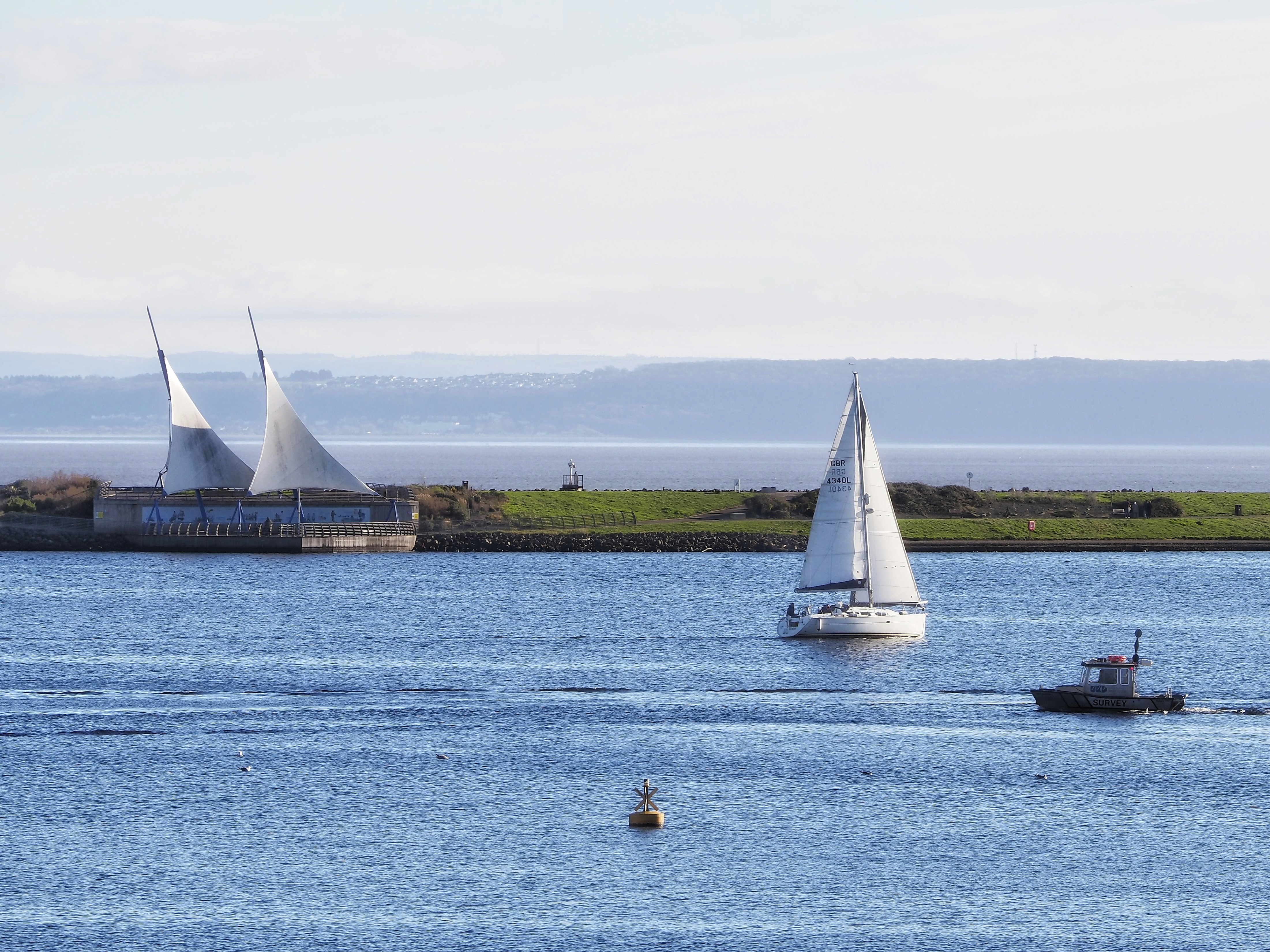 Sailboats on a Quiet Bay Under a Pale Sky