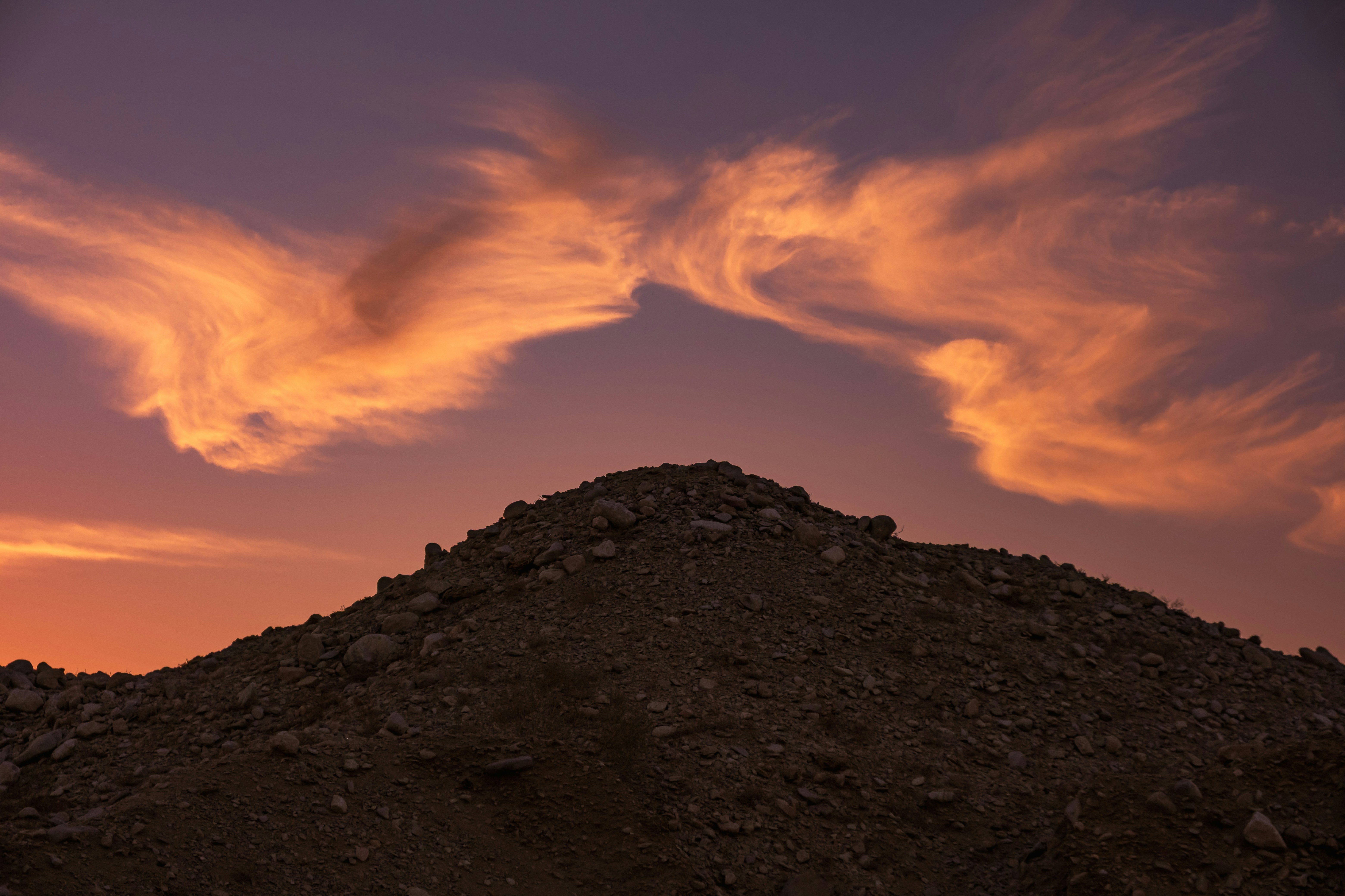 Flame-kissed Ridge: A Sunset Over Quiet Pile
