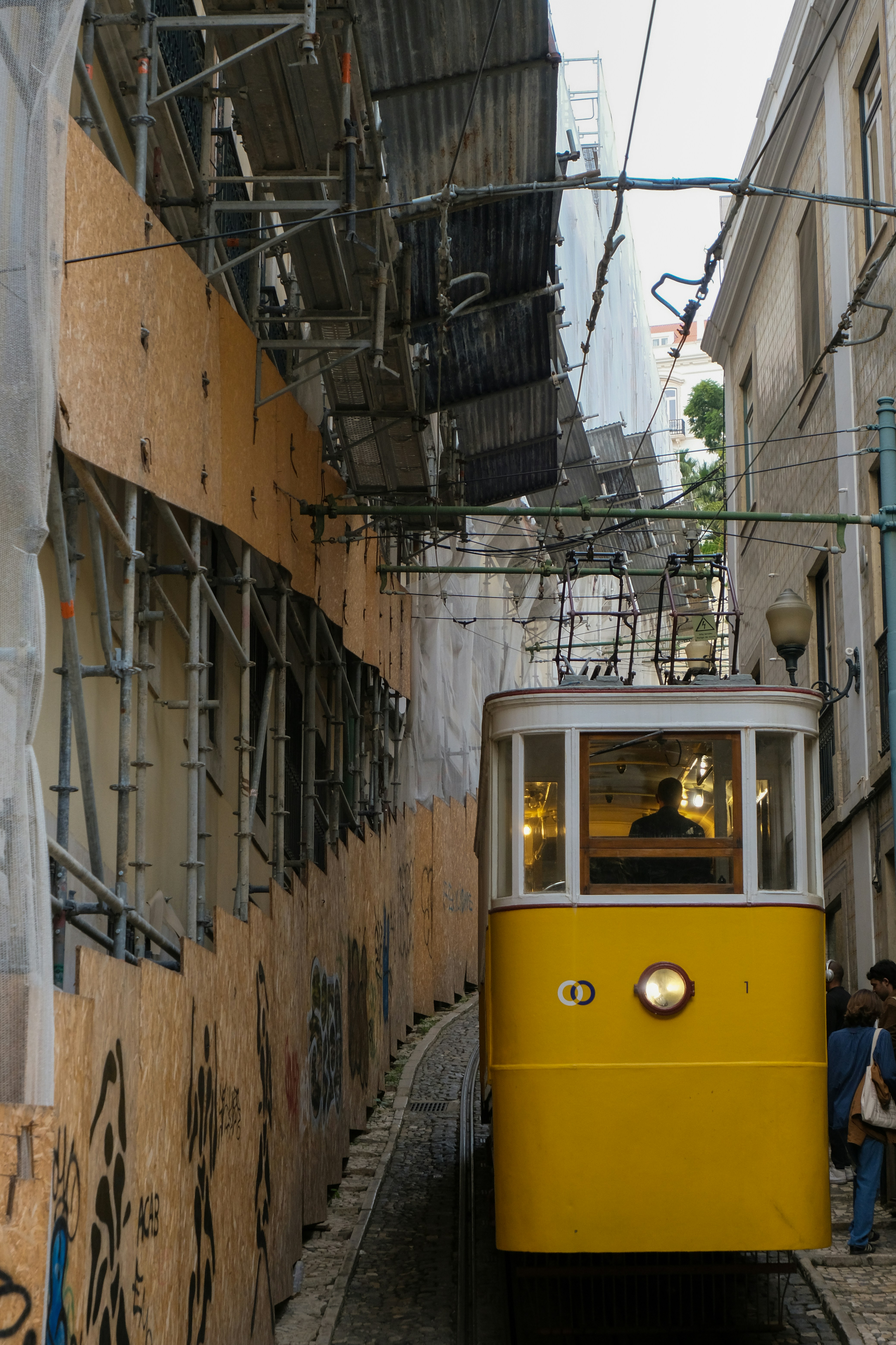 Golden Tram in a Narrow Linet: City Climb through scaffolding