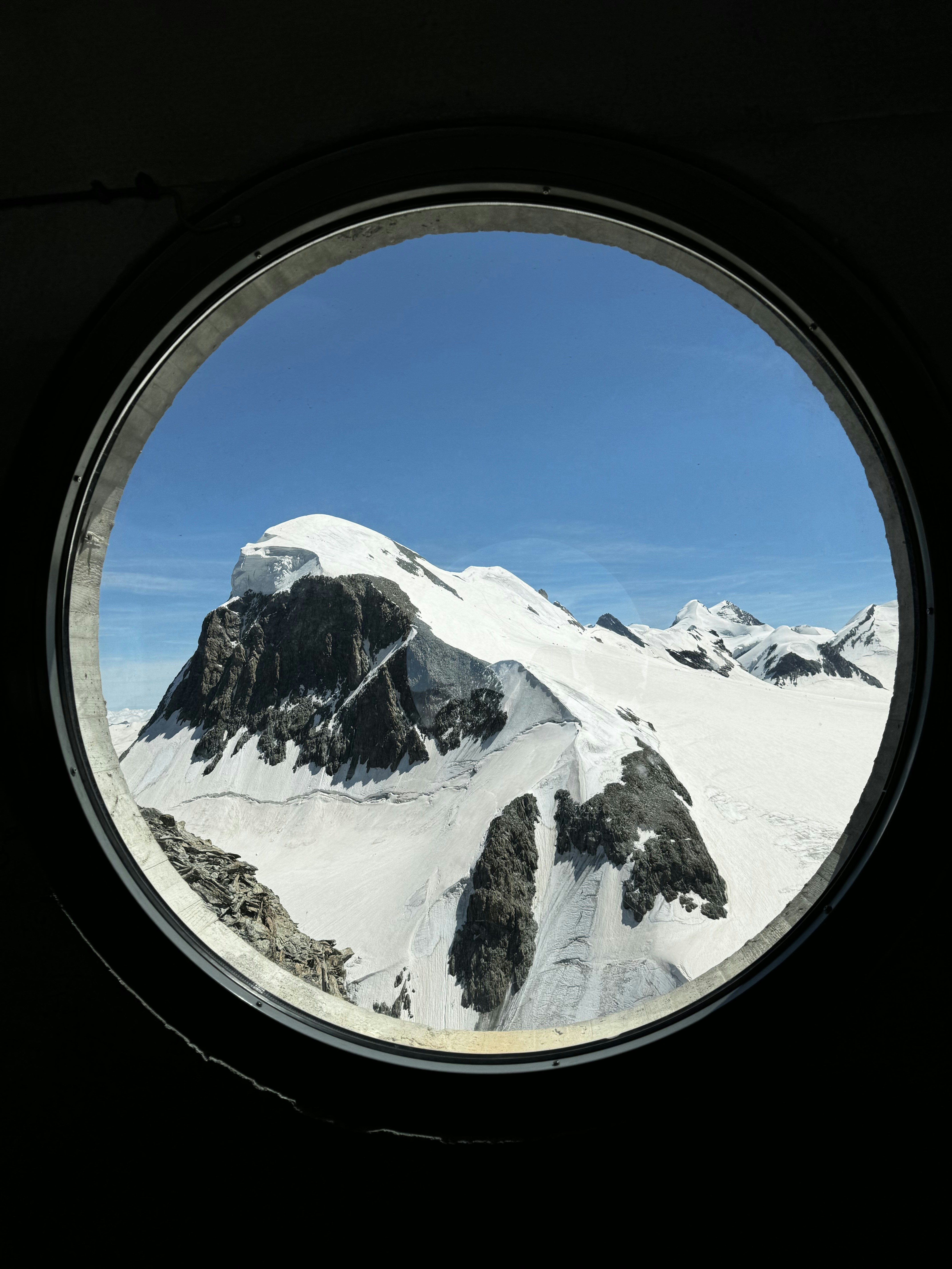 Snowbound Ring: A Mountain Vista Through a Circular Window