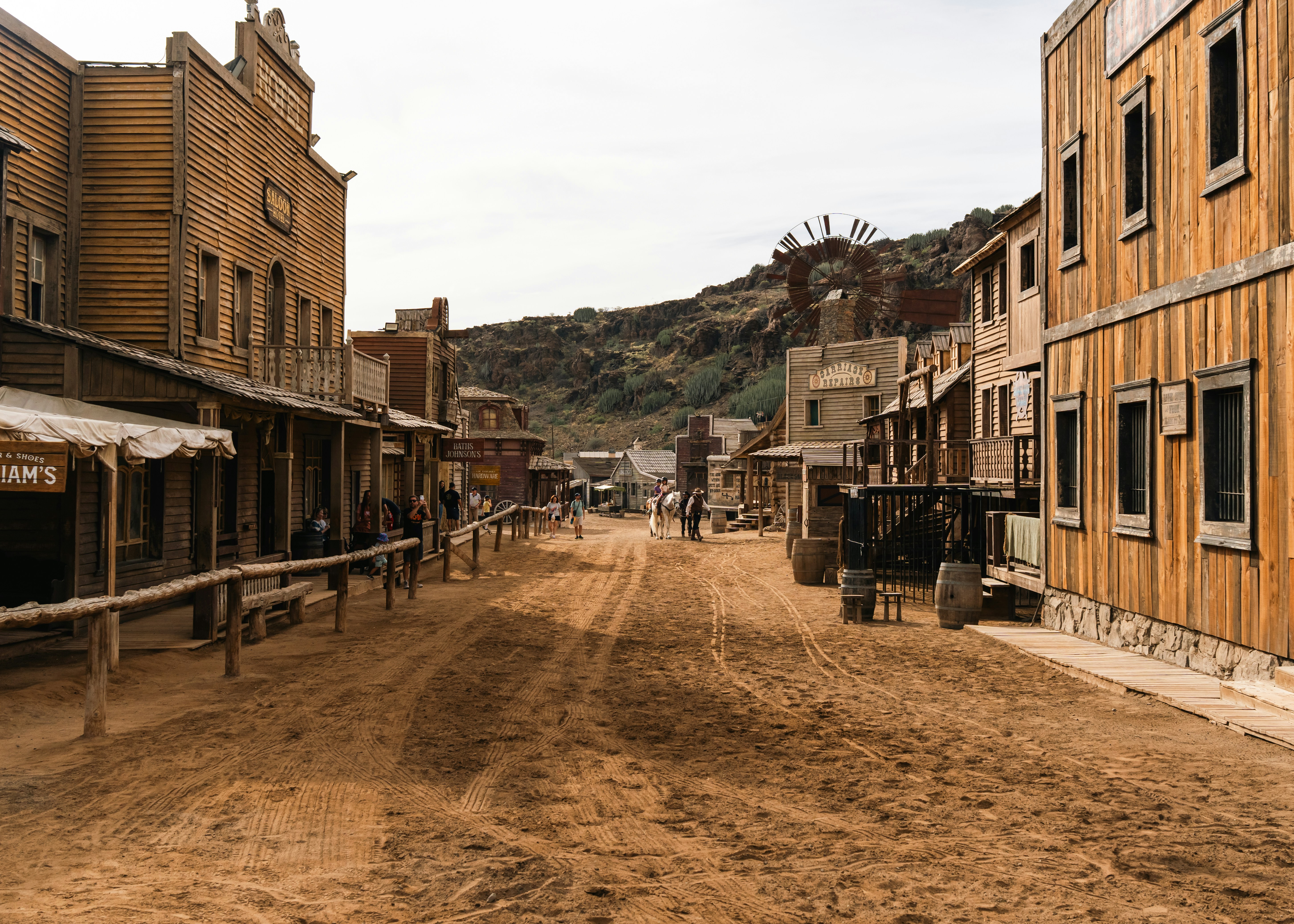 Dust and Wooden Fortunes: A Swift Western Street at Noon