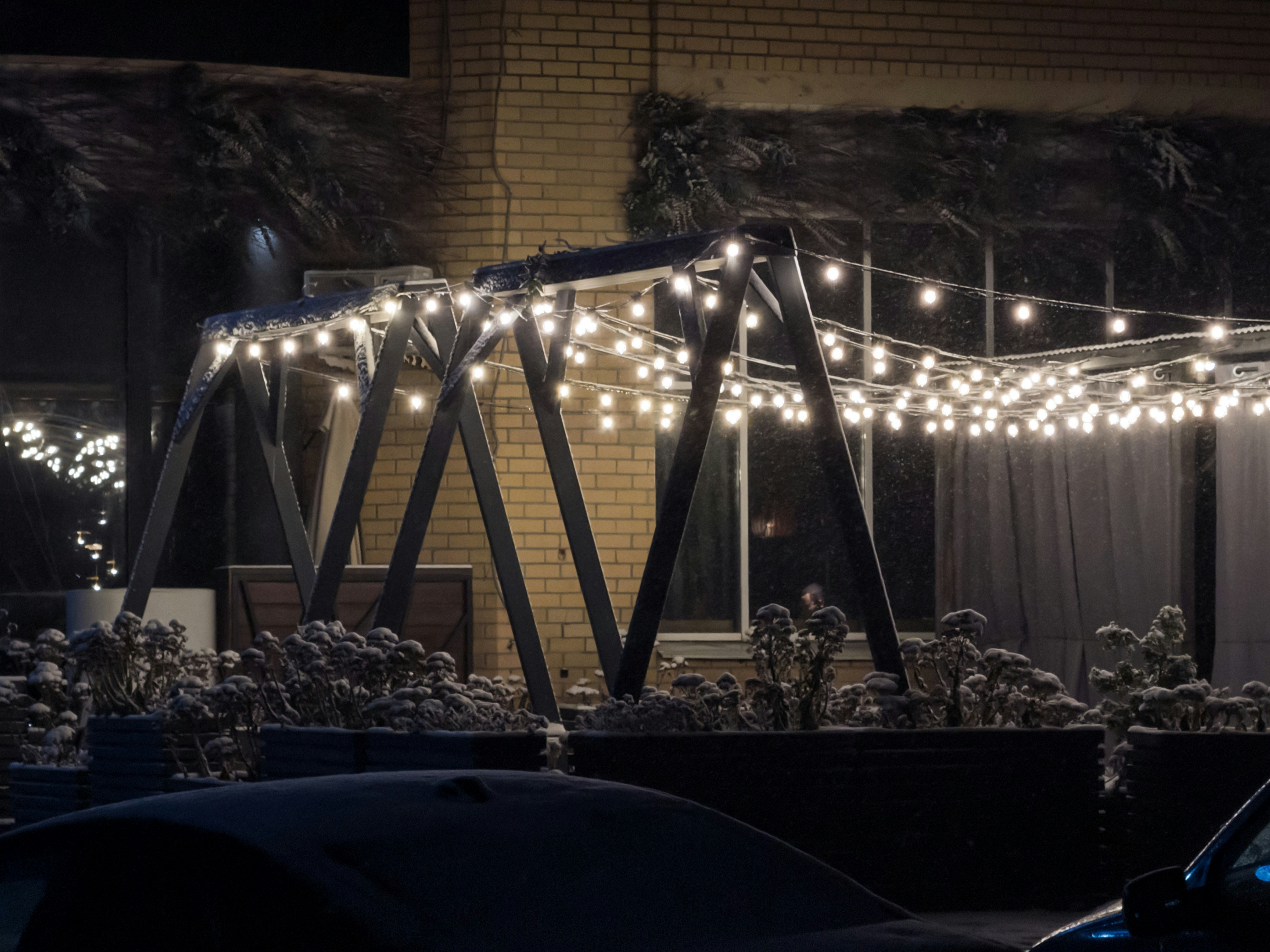 String Lights Over a Garden Terrace at Night