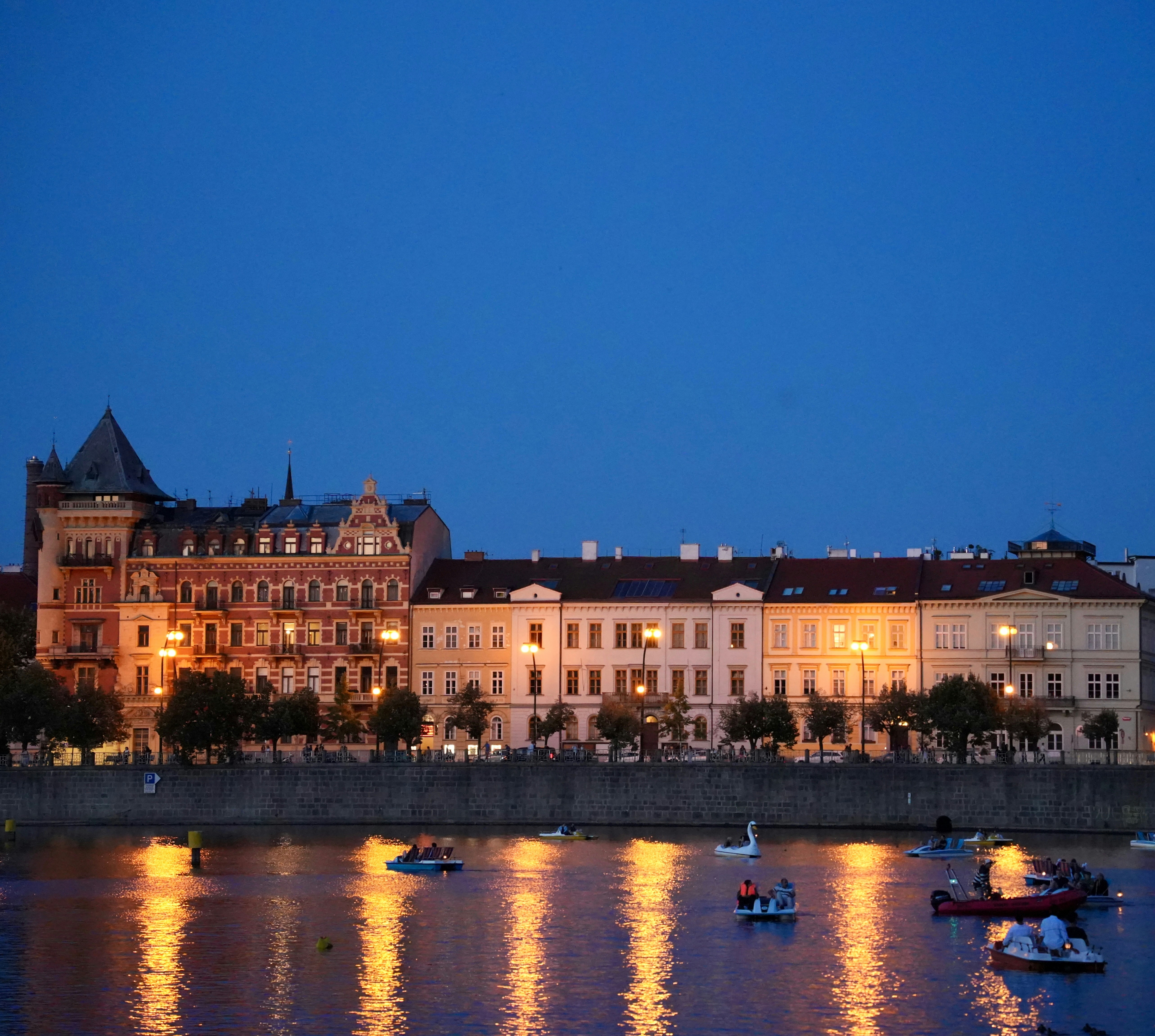 Riverside Eve: Lit Facades Reflect on the Quiet Quay