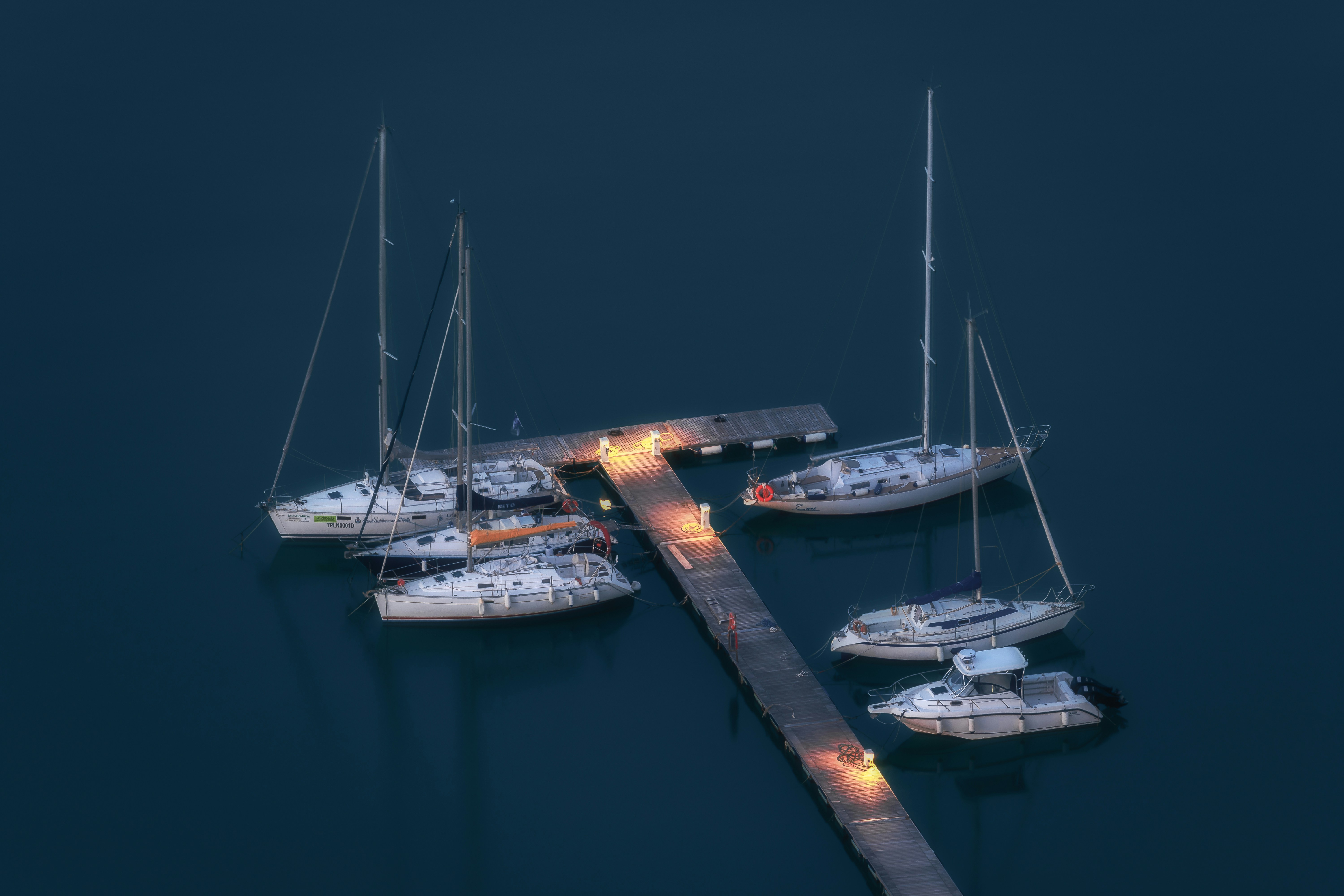 Midnight Marina: Boats Resting Under Dim Dock Lights