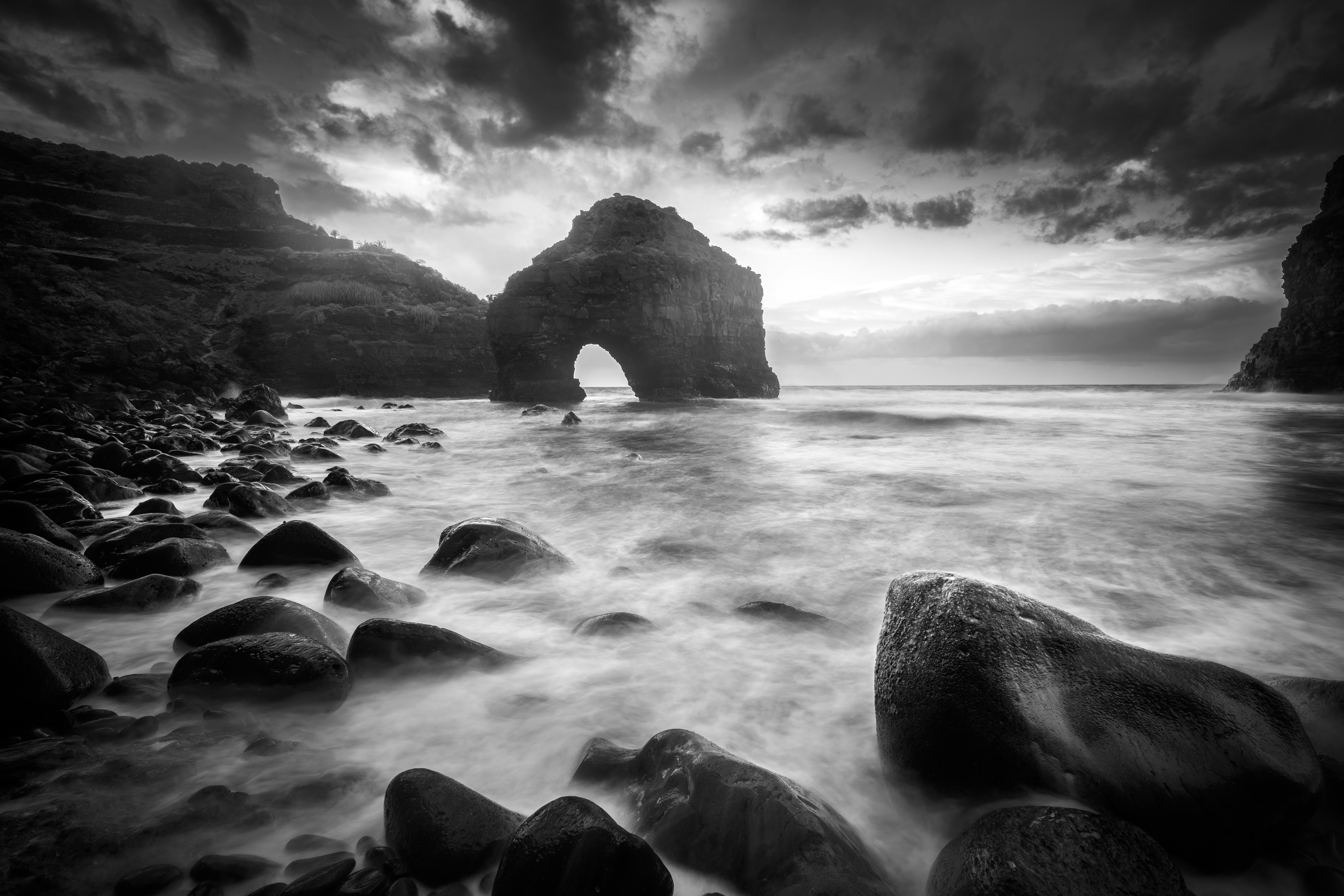Black-and-White Arch: Coastal Rock Gate Reaches Toward the Horizon