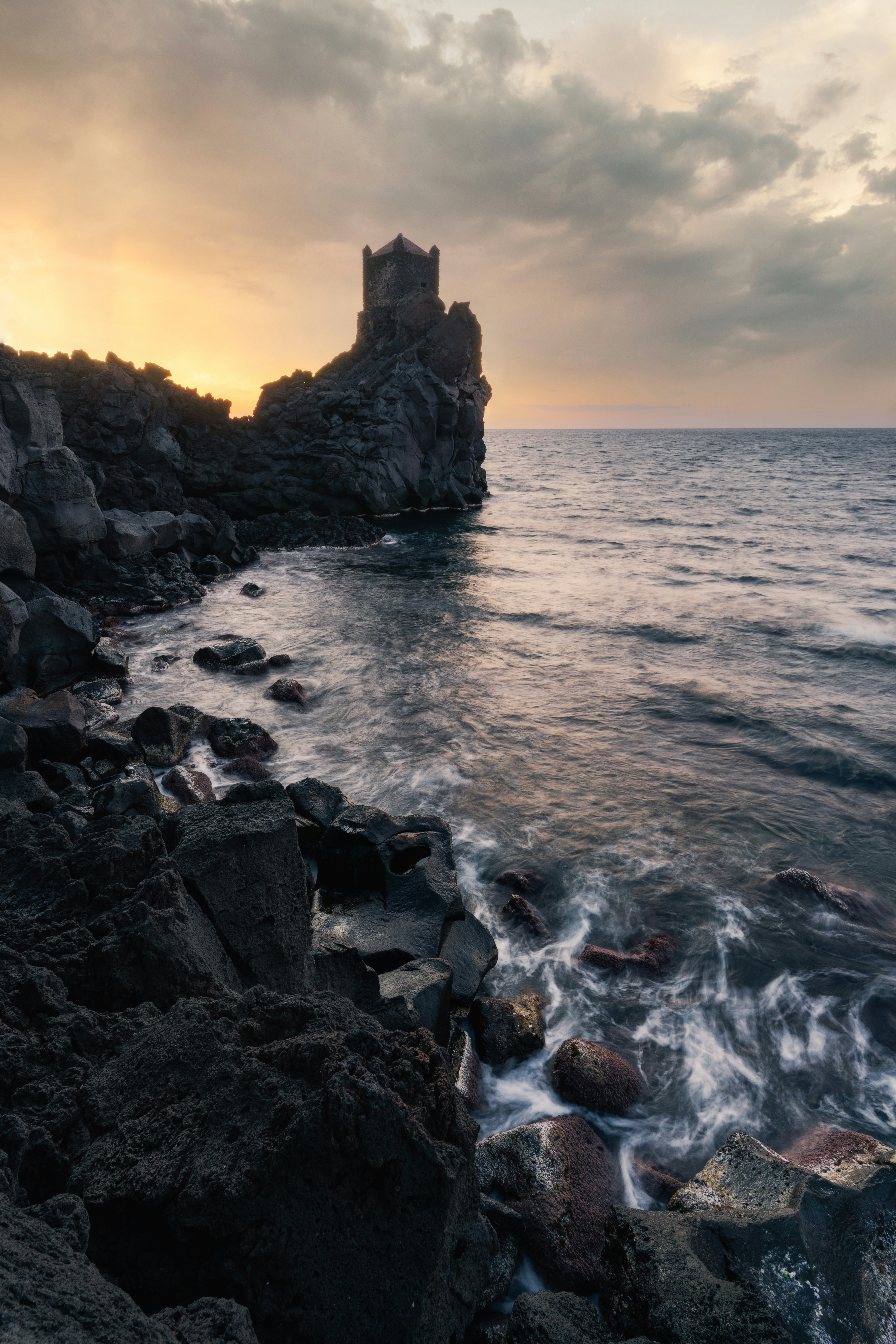Sunset Fortress: A Luminous Peak of Basalt and Sea