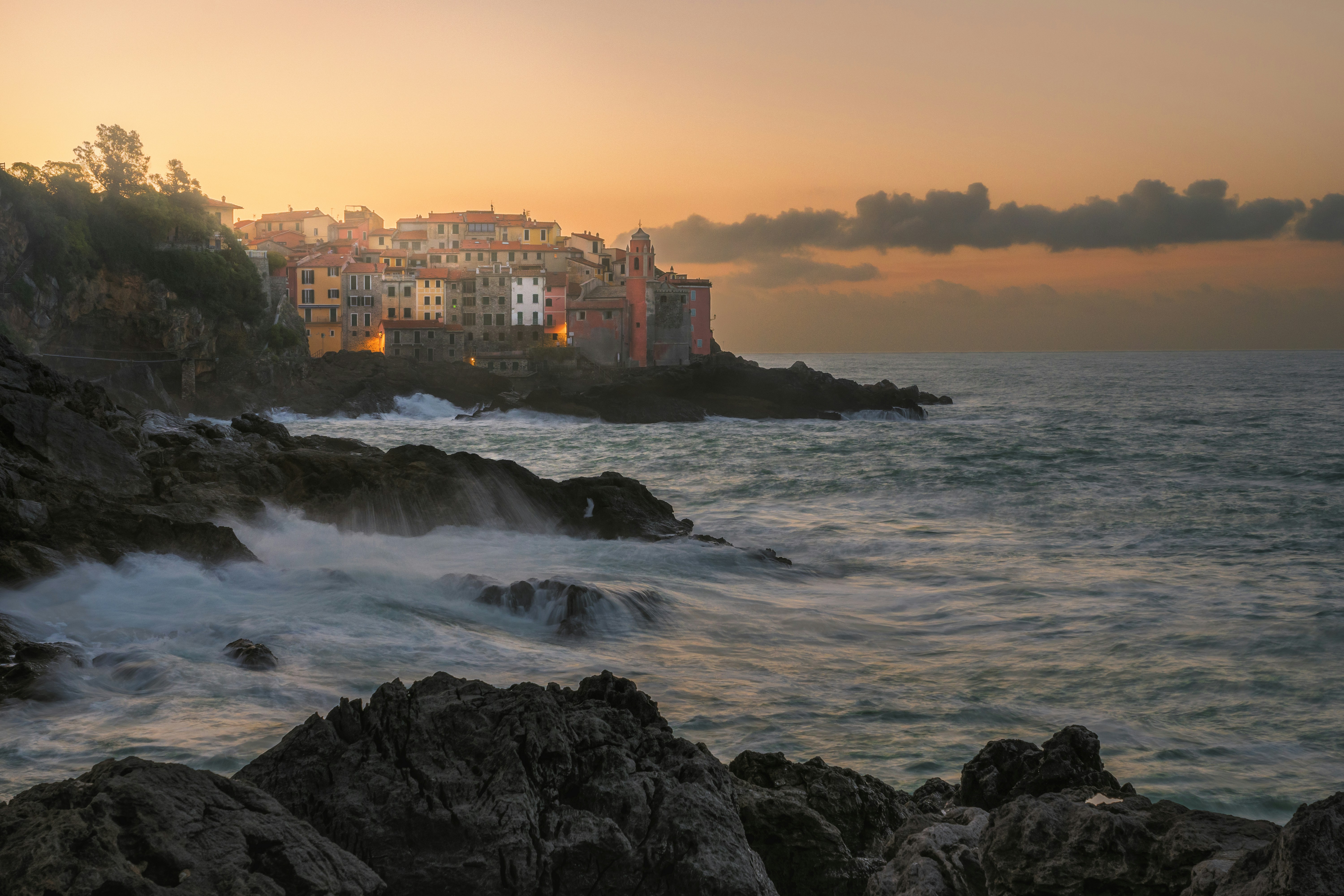 Sunset Dunes: A Coastal Village Clings to Rock at Dusk