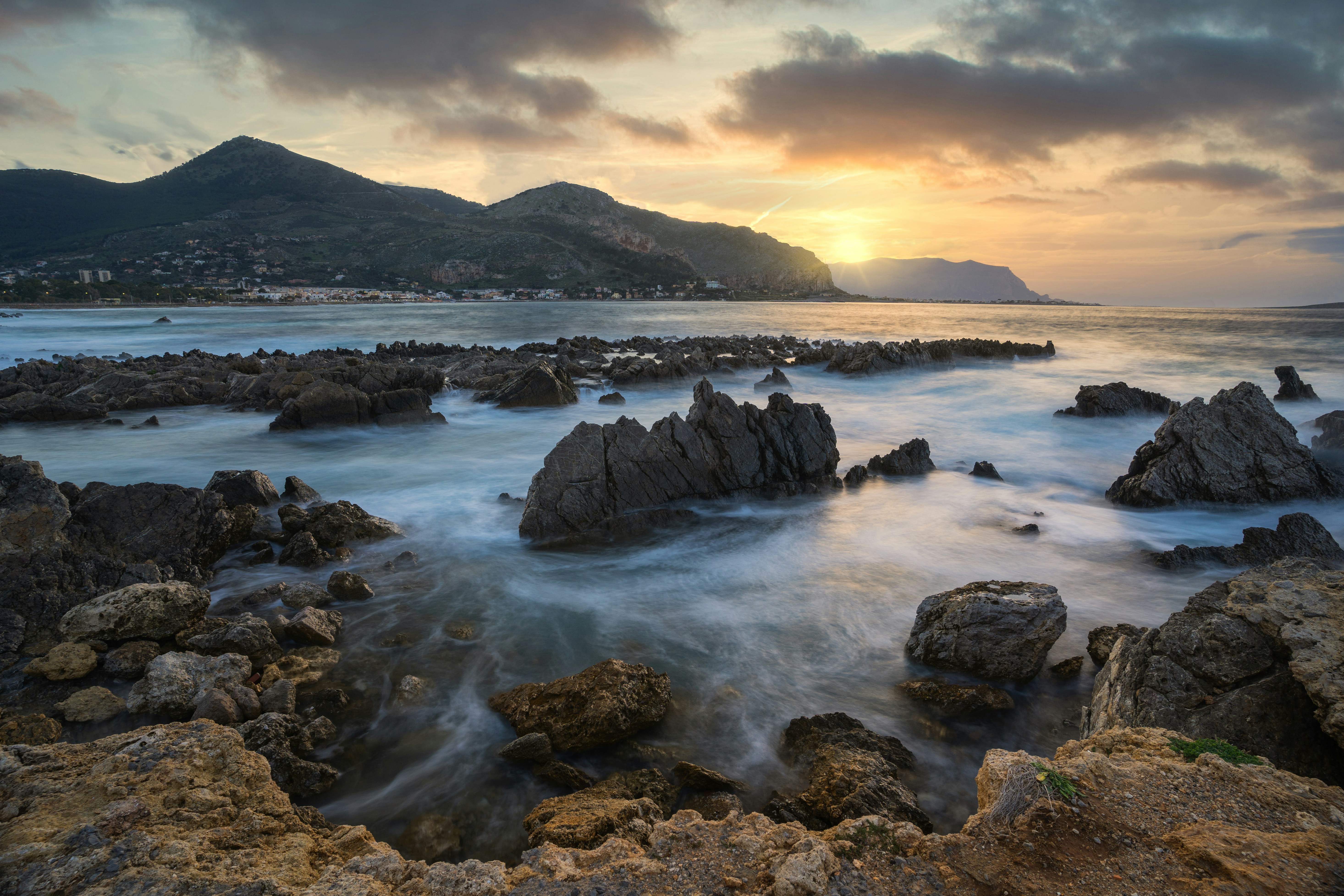 Sunset Over Rugged Breakers: A Coastal Portrait at Dusk