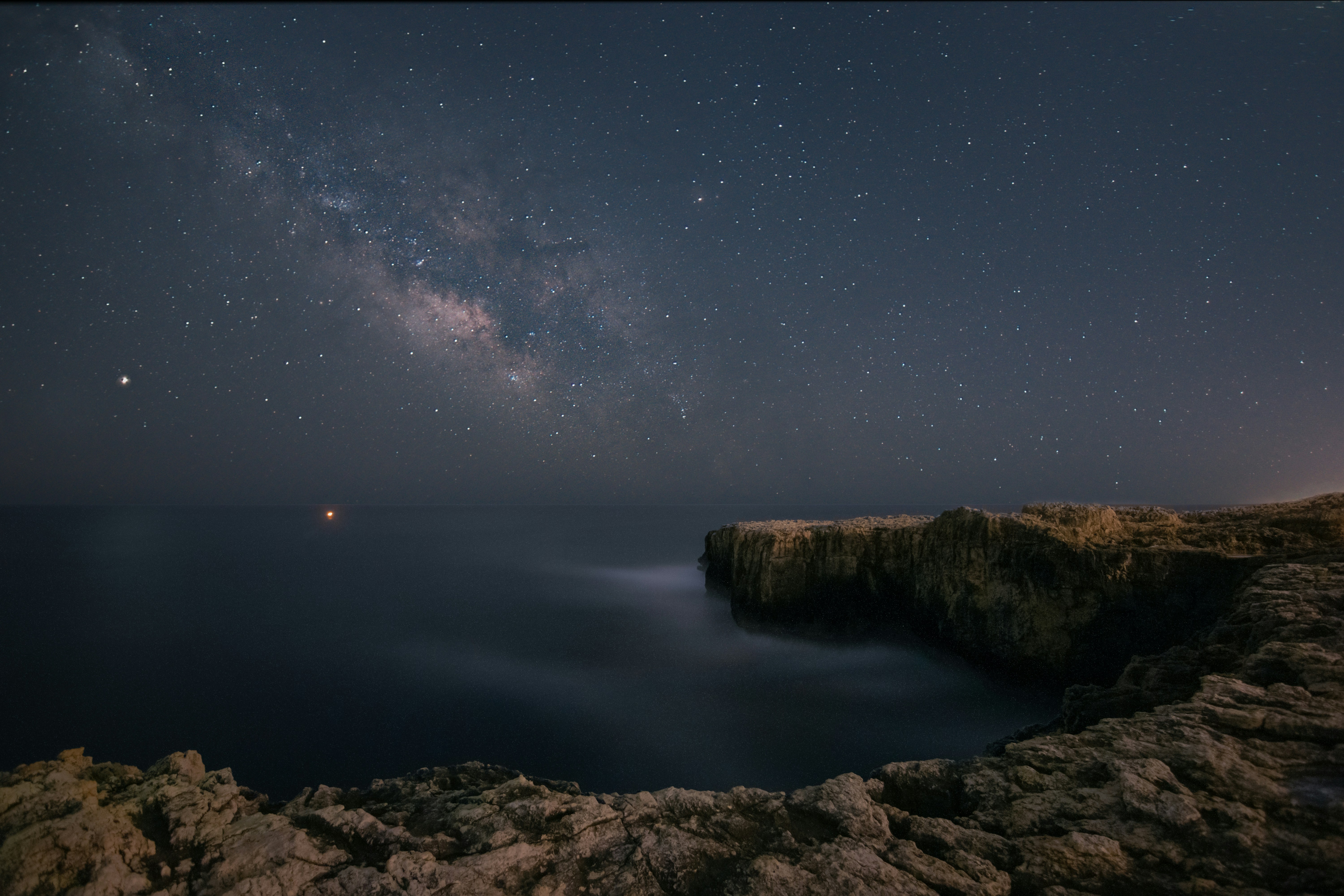 Milky Way over rugged coastline: starlight and cliff edge