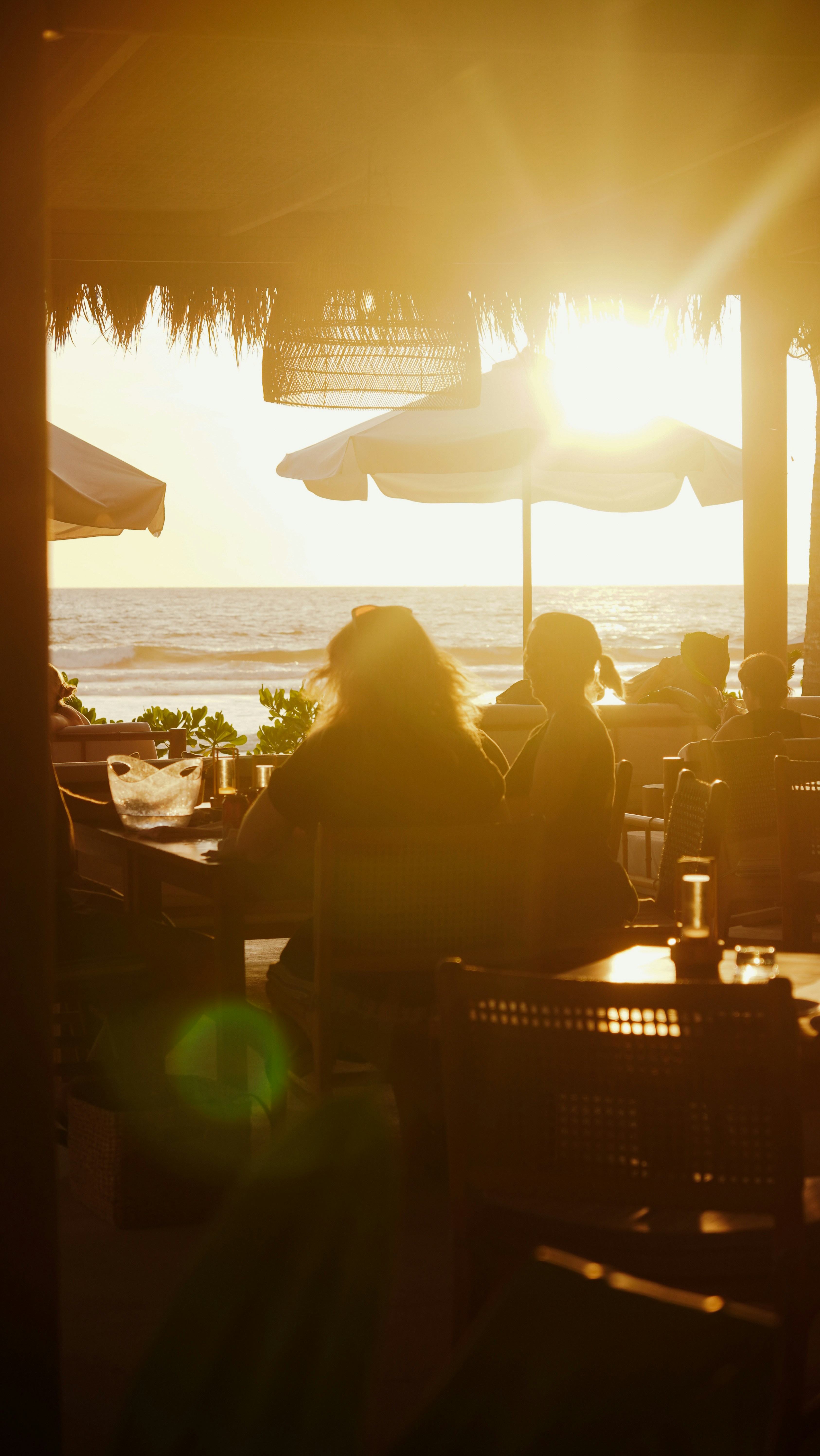 People dining at a beachside restaurant at sunset photo – Free Beach ...