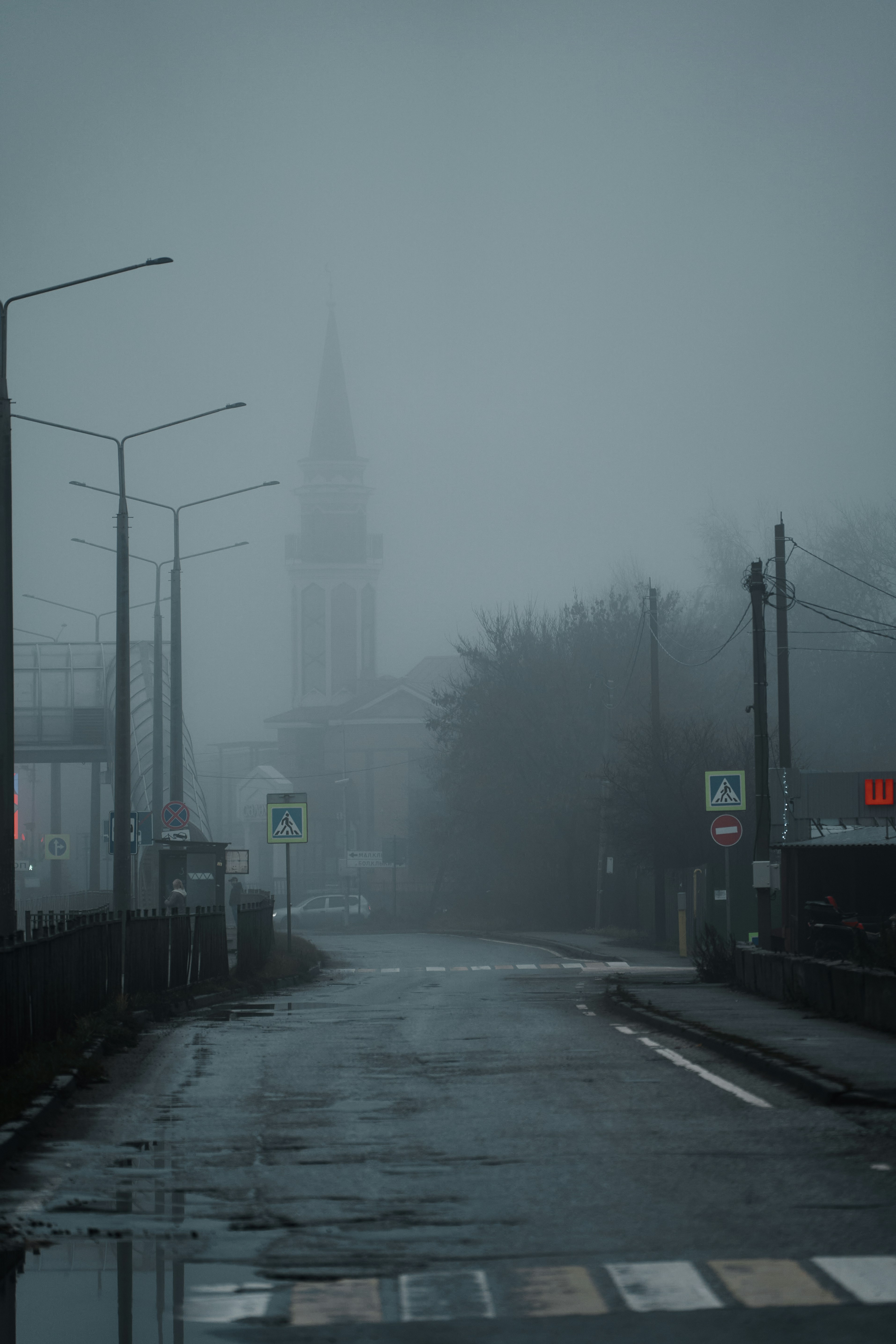 Fogbound Street with Church Spire Emerging from the Mist
