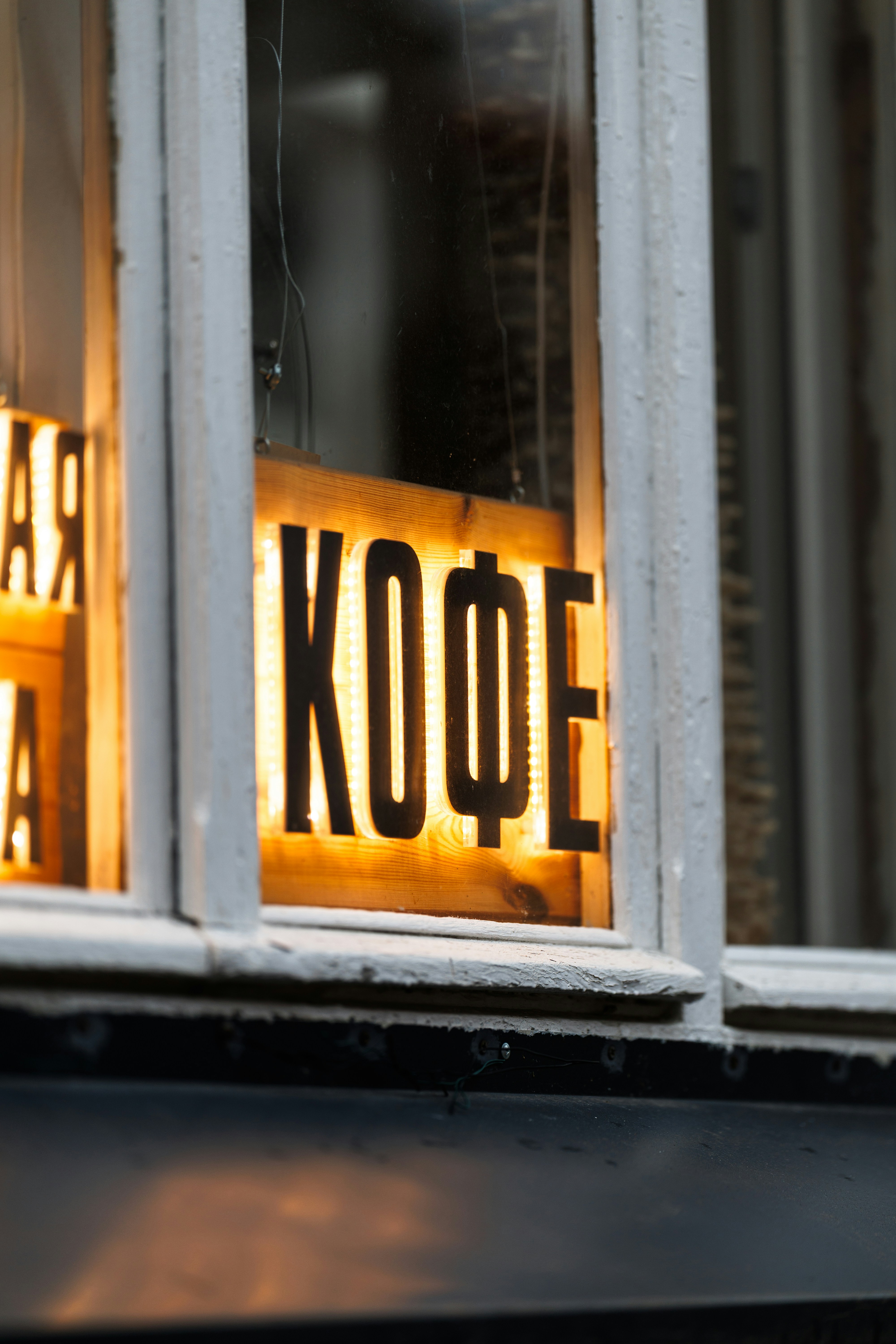 Warm Signlight Through Frosted Glass: A Window of Cyrillic Echoes