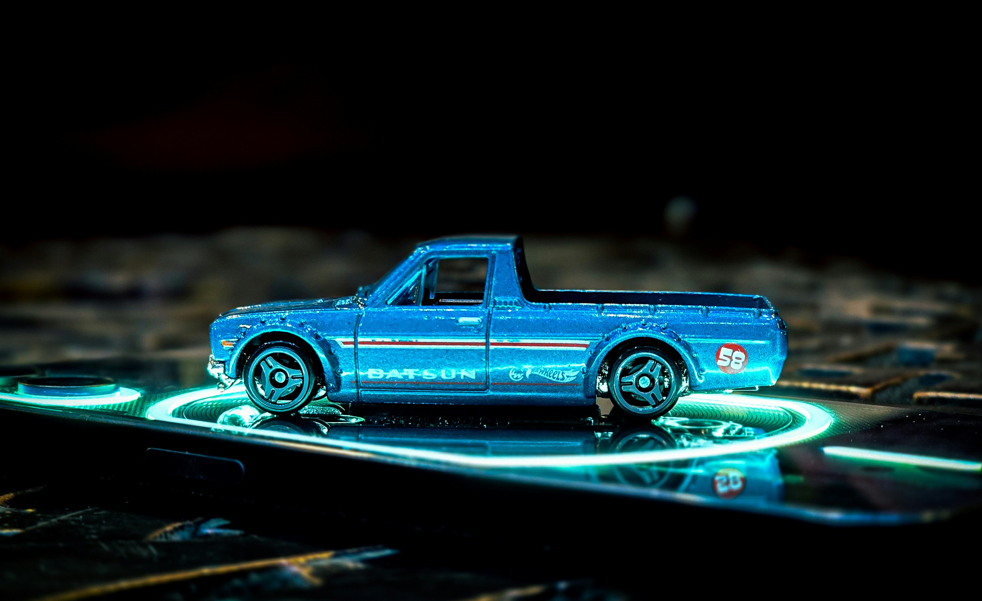  Neon-lit blue toy pickup riding a glacial ring