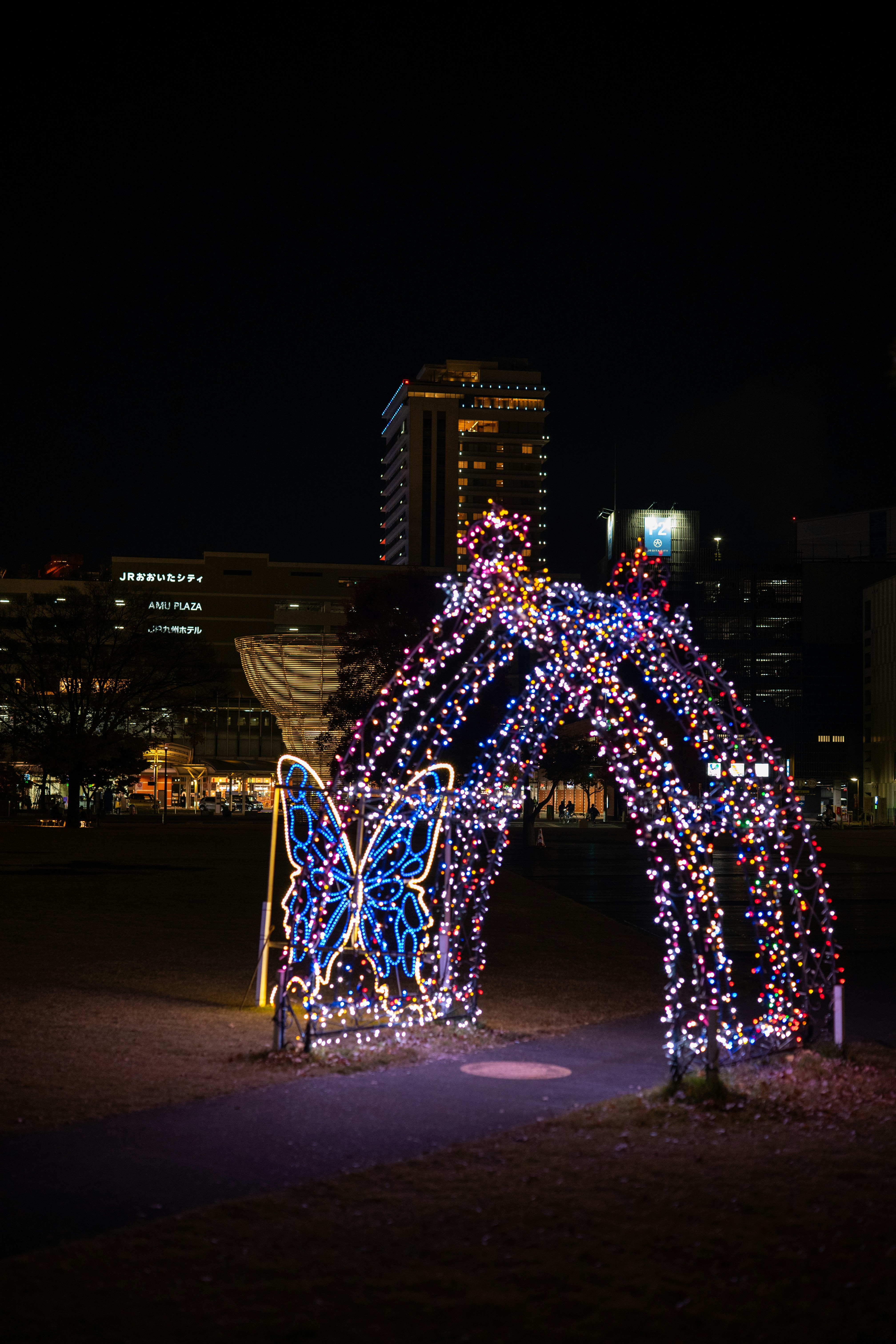 Illuminated Butterfly Arch: Nightscape Garden of Neon Lights