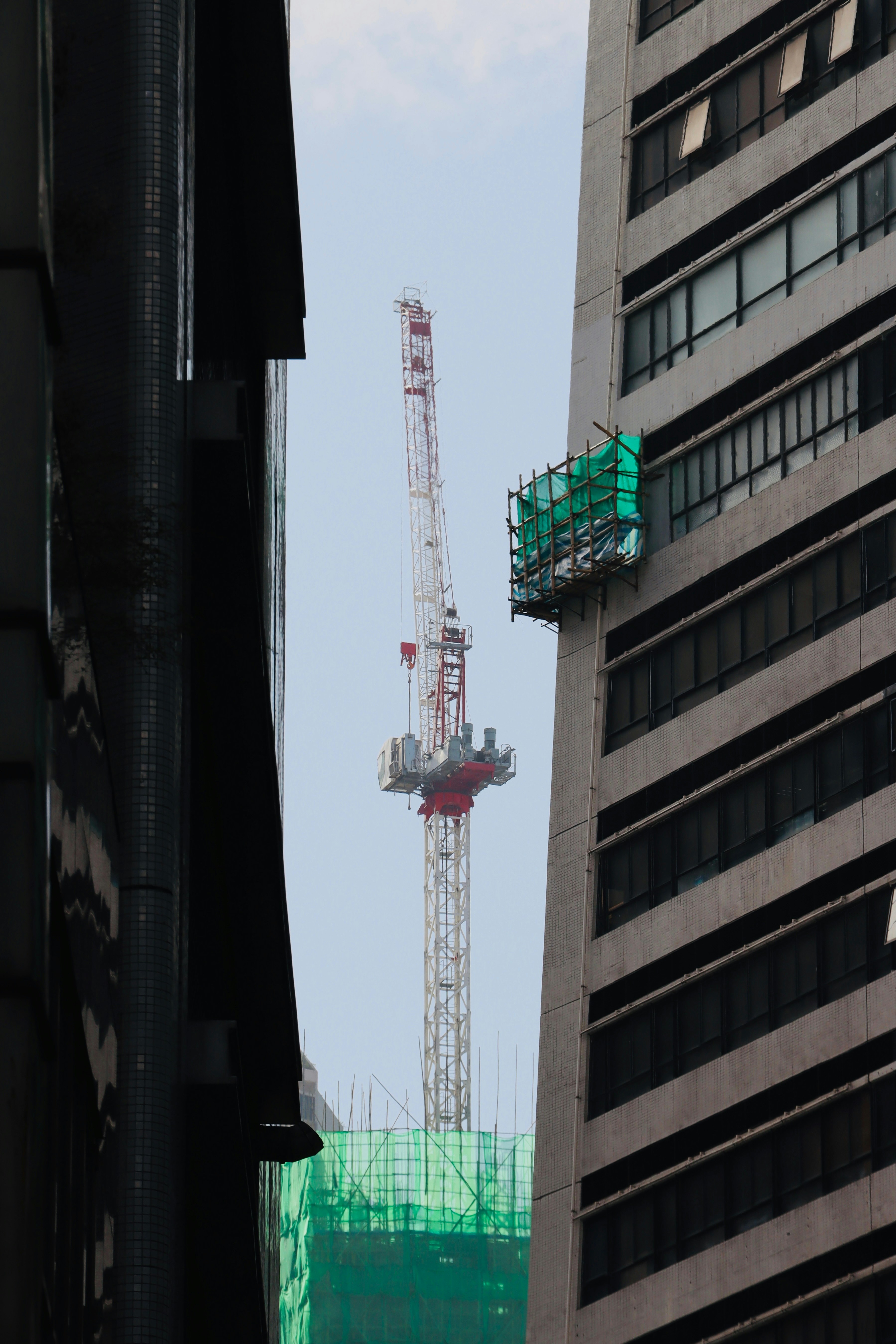 Crane Between Towers: A Narrow Urban Skyward
