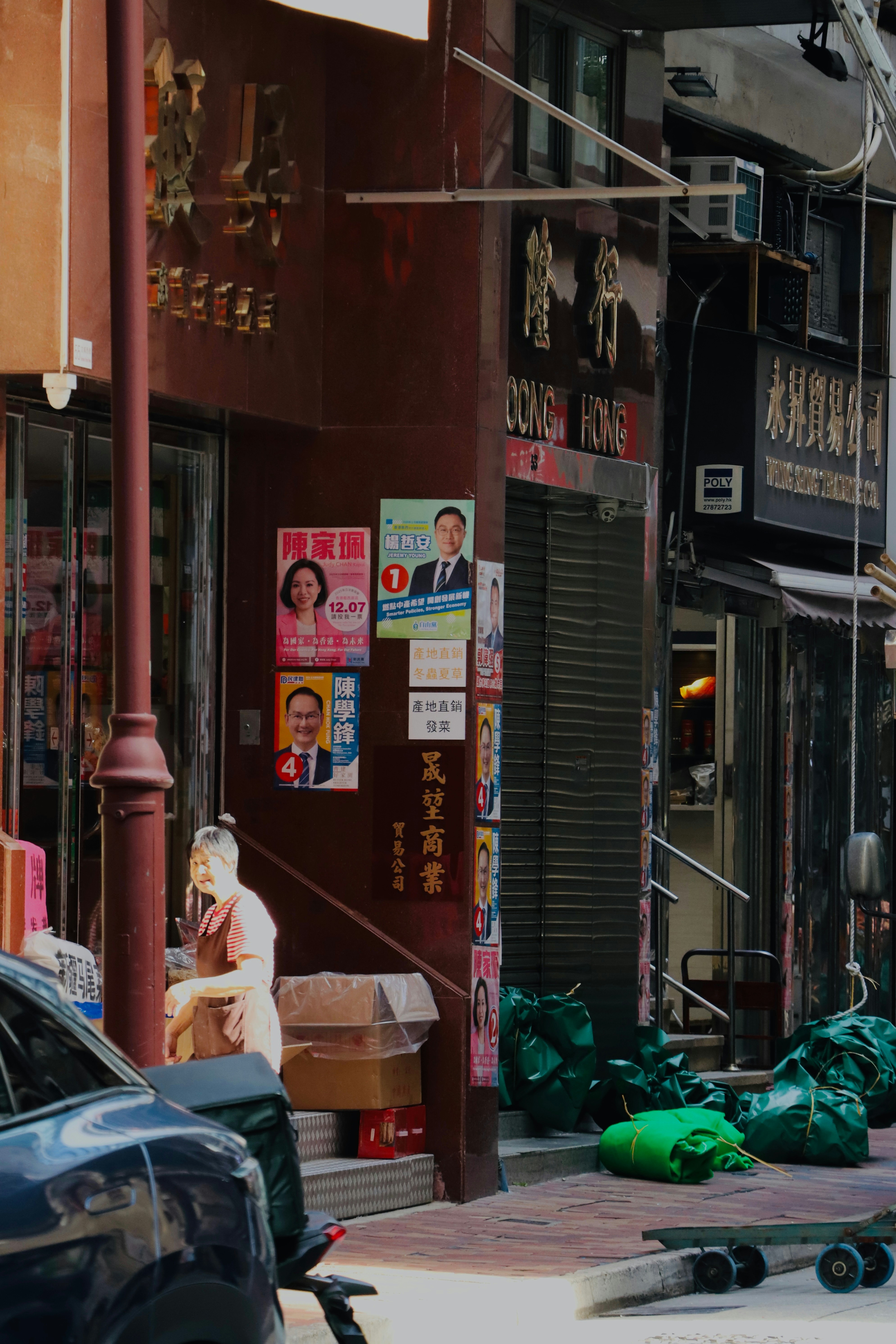 Neon Posters and Quiet Street Corner in a Busy Chinatown