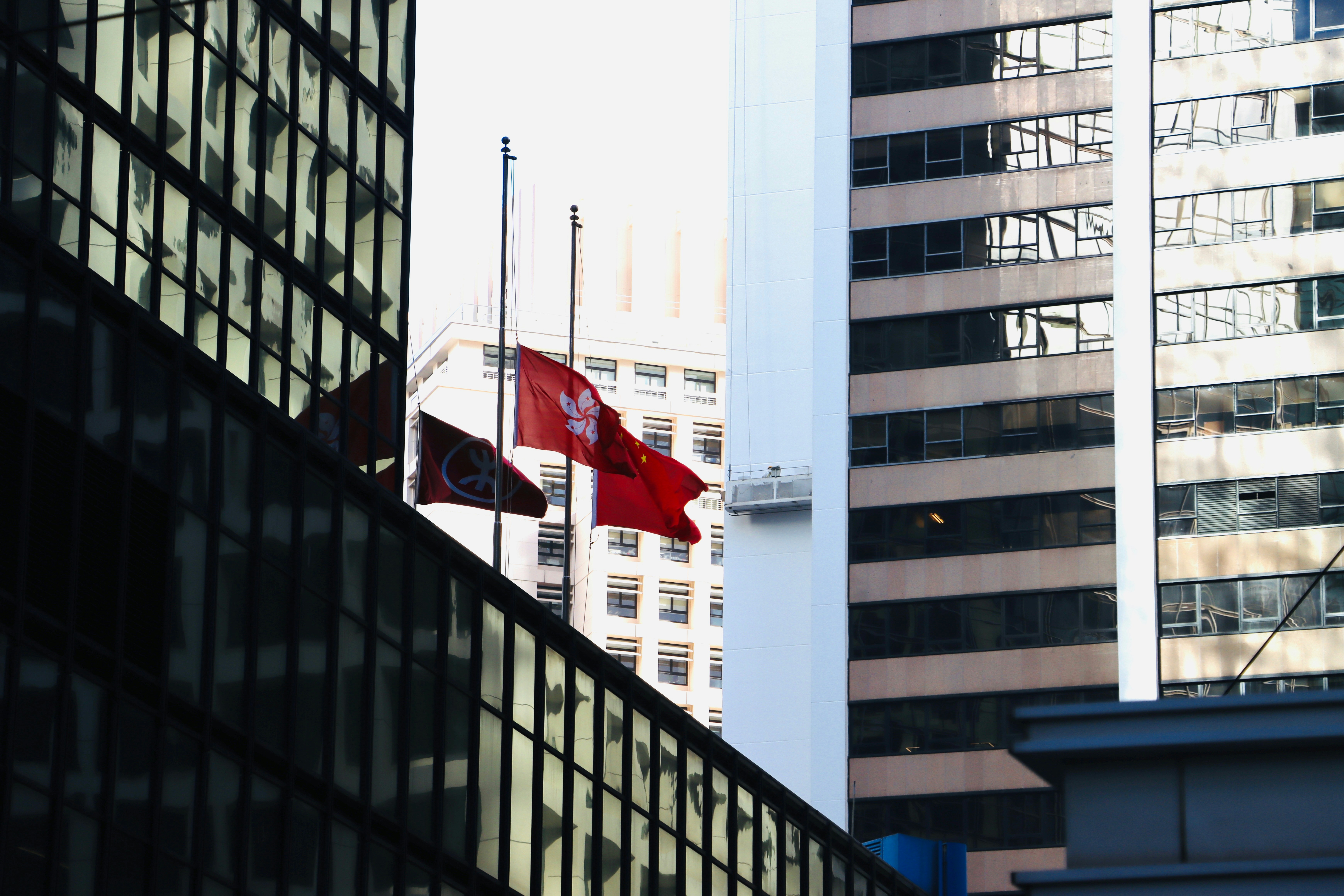 Flag Amid Skyscrapers: A Quiet Moment Between Glass and Steel