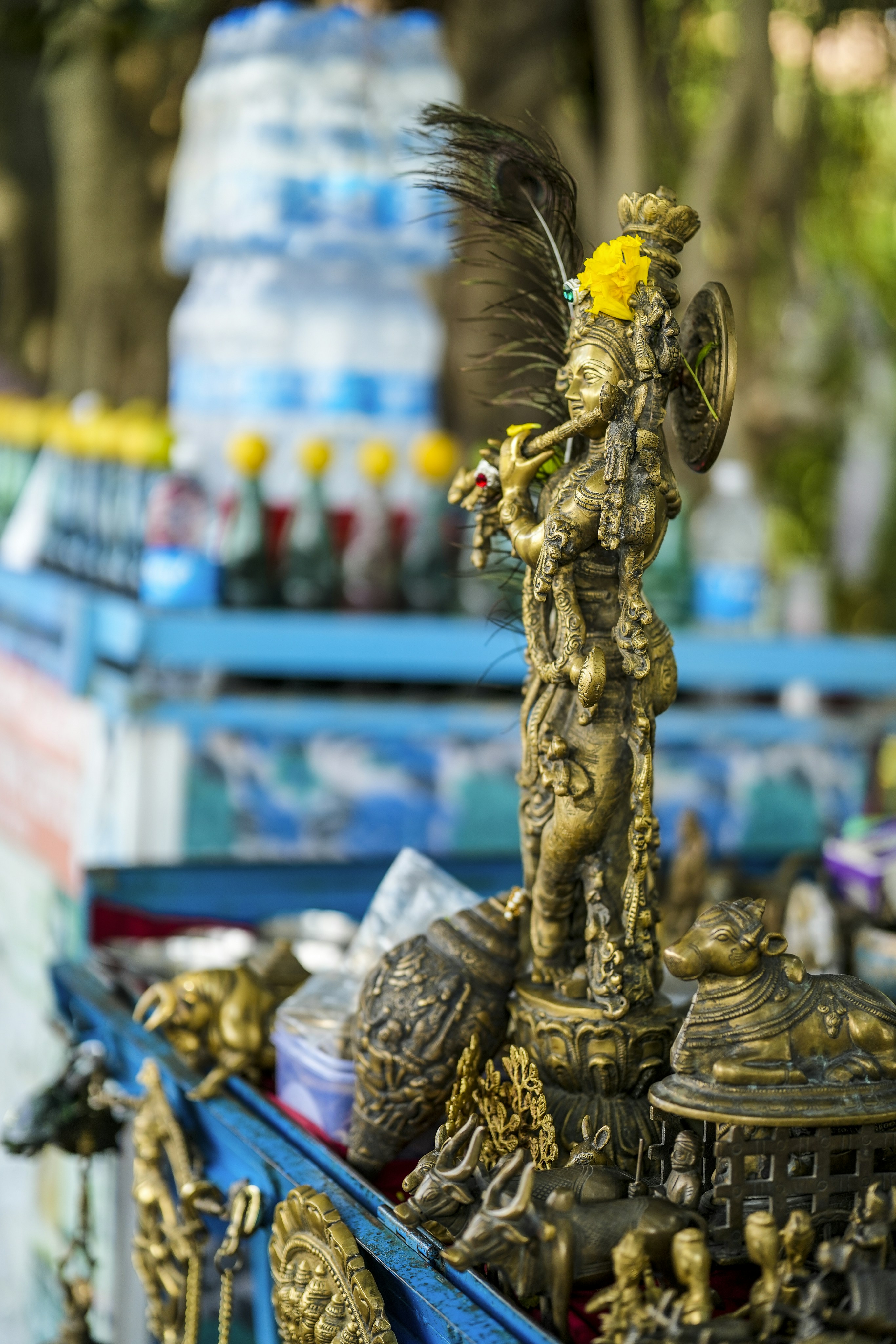 Golden Shrine Figurine Emerges from a Blur of Market Colors