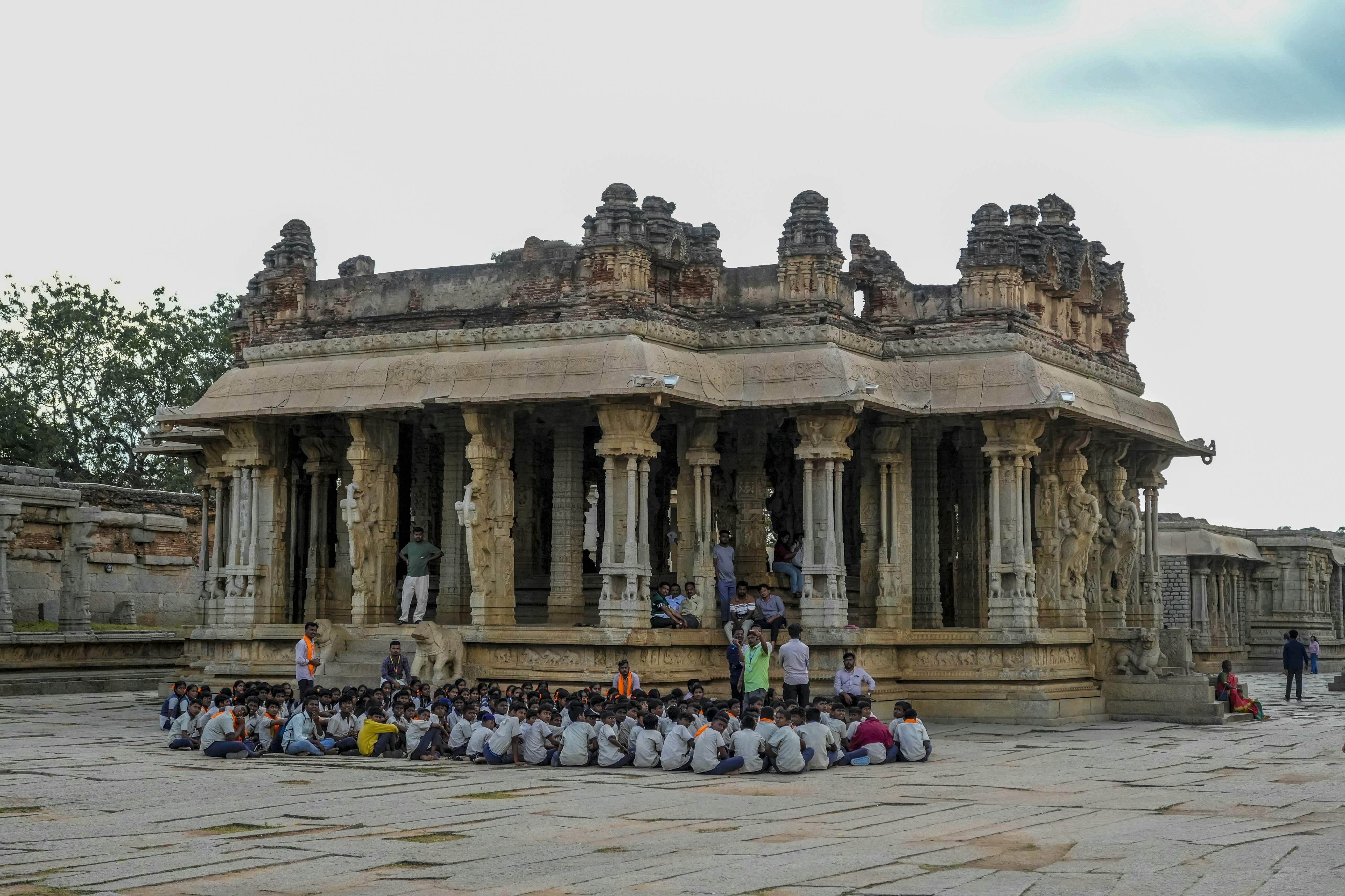 Circle of Clay and Stone: Children Gathered in Front of an Ancient Temple